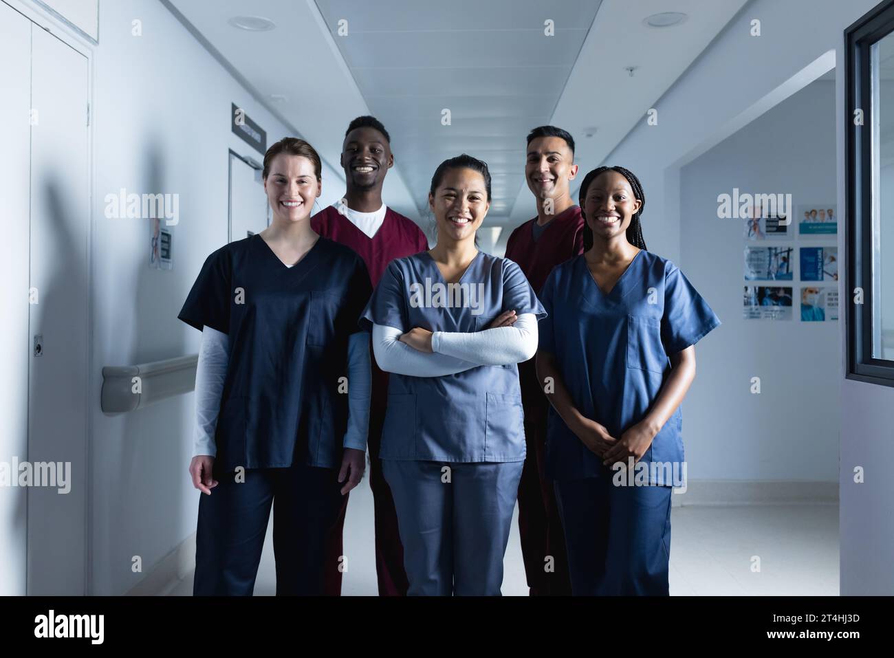 Portrait of happy diverse male and female doctors wearing scrubs in ...