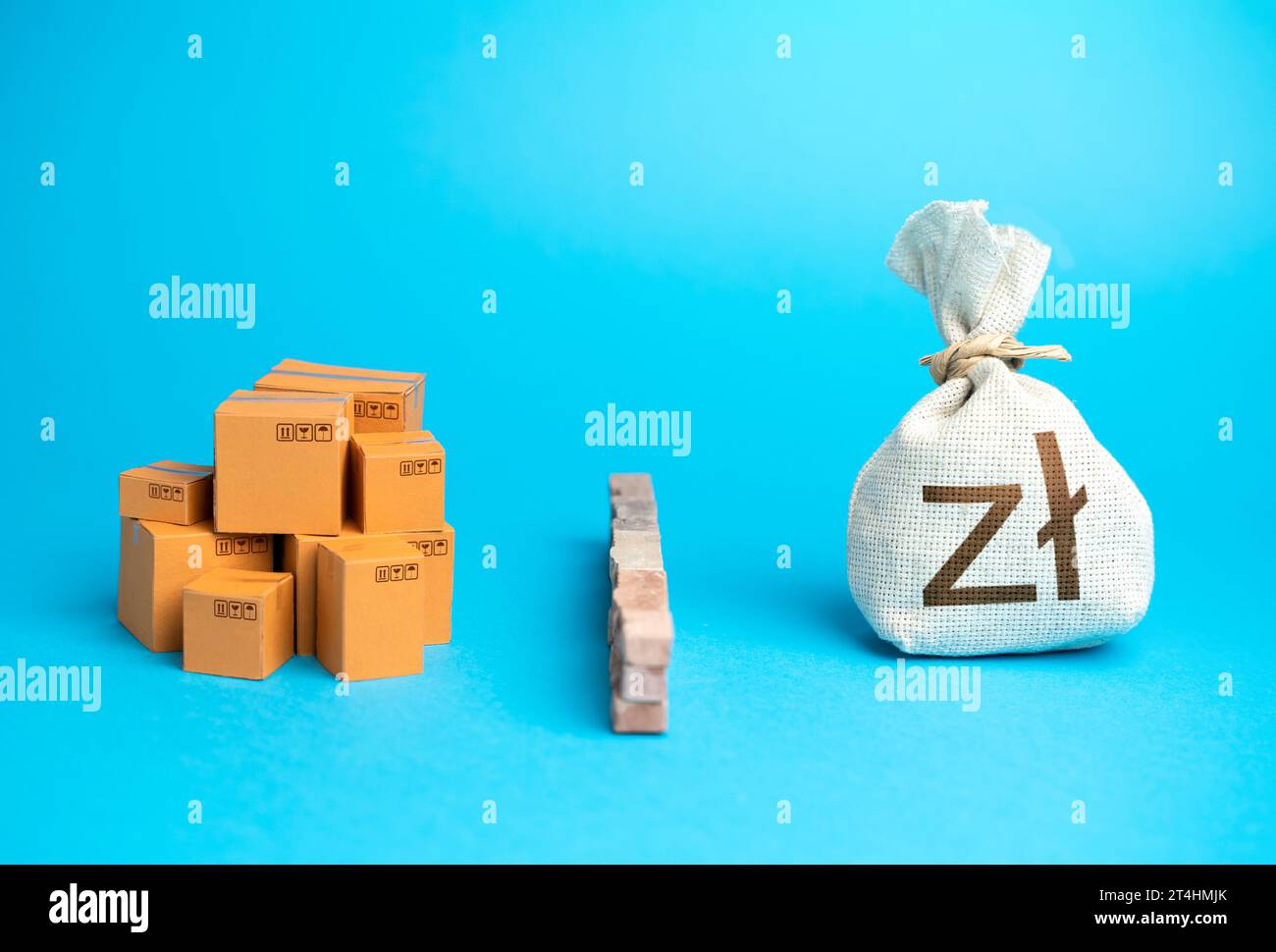 Boxes with goods and polish zloty money bag are separated by a barrier ...