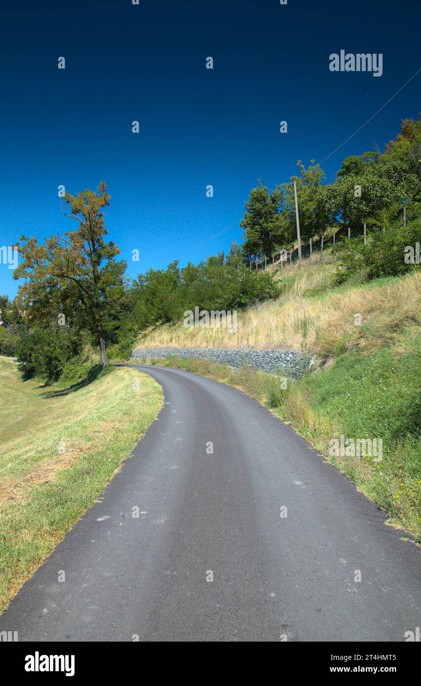 Road in a park by the hillside at sunset Stock Photo - Alamy