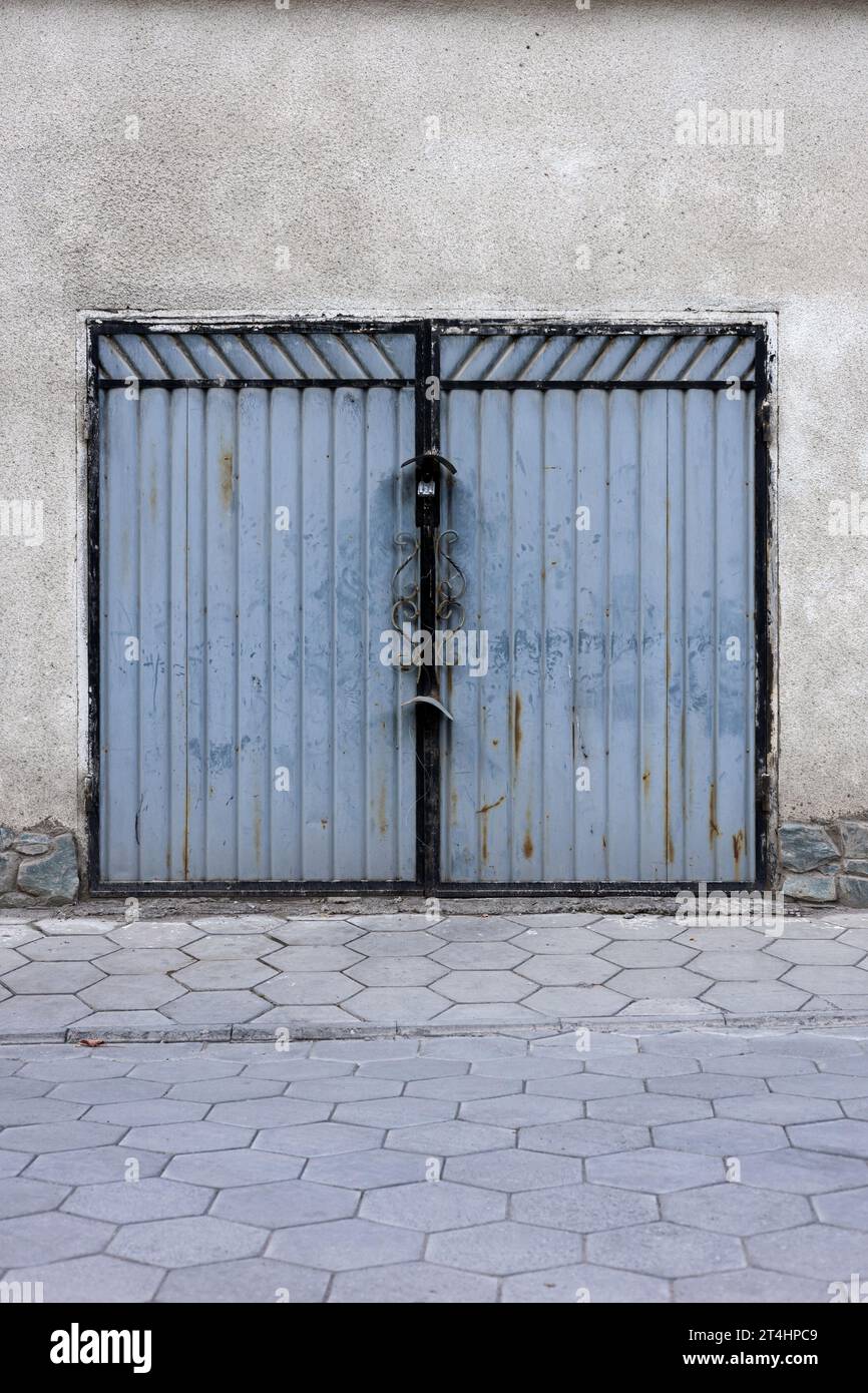 Old Car garage steel doors locked with a lock in the courtyard. metal ...