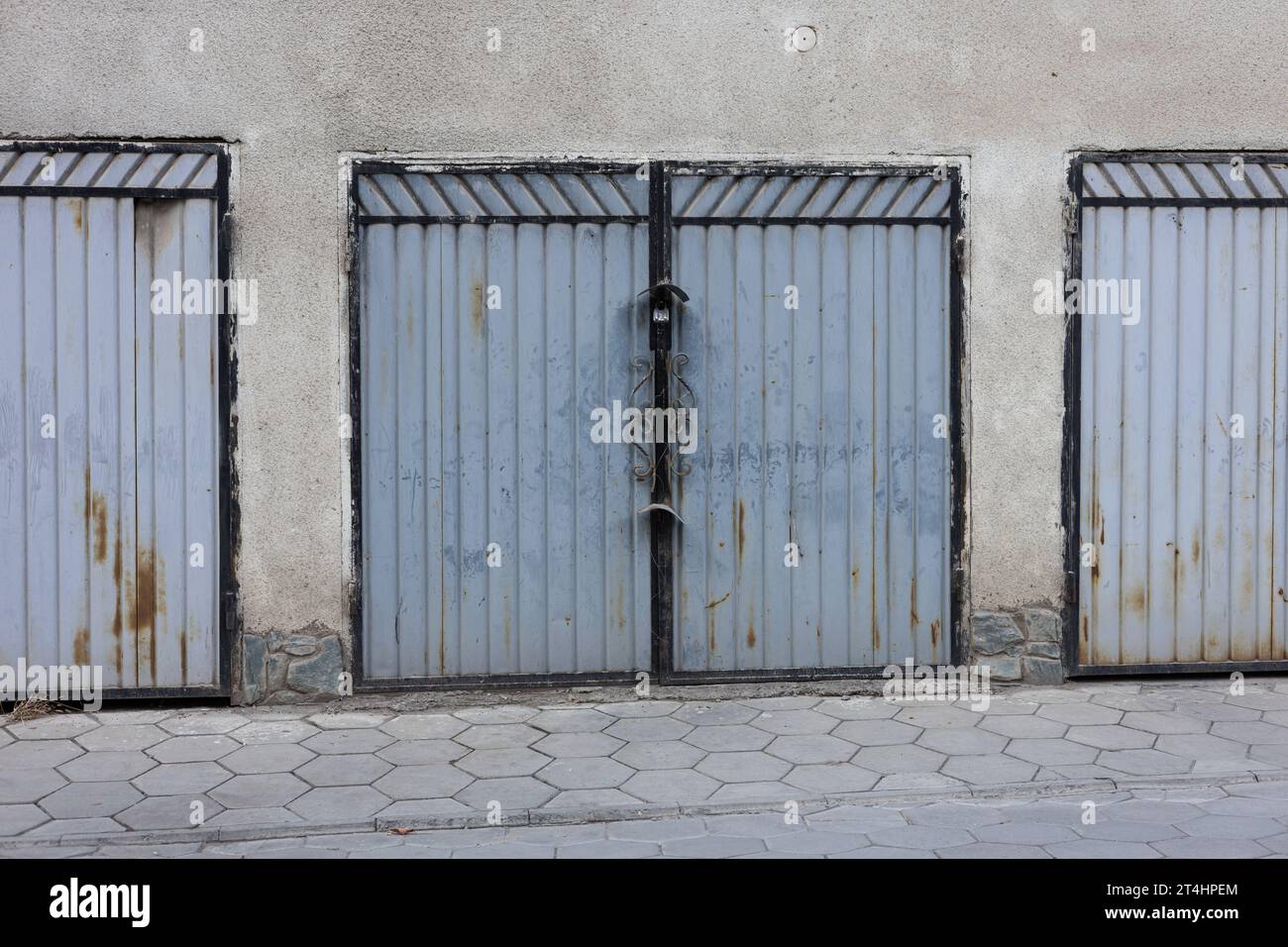 Old Car garage steel doors locked with a lock in the courtyard of an ...