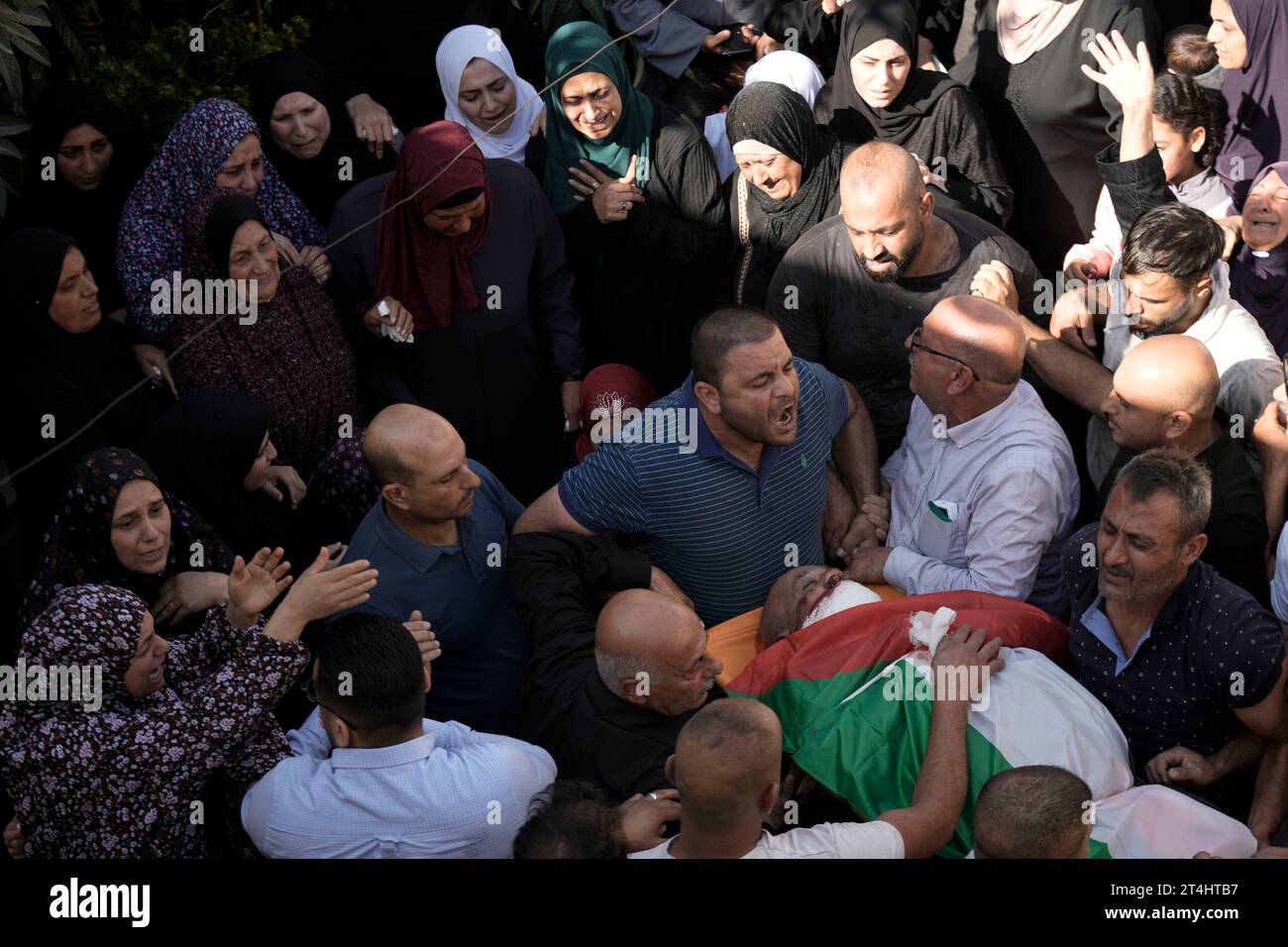 Palestinians carry the body of Rawhi Sawafta, 70, after he was killed ...
