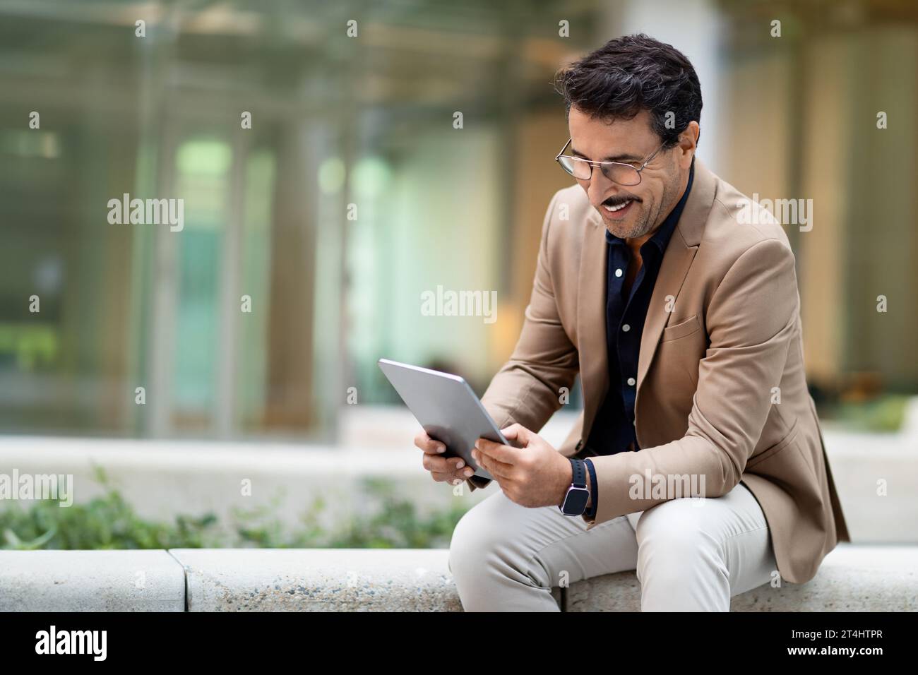 Busy mature man in formal suit manager using tablet outdoors Stock ...