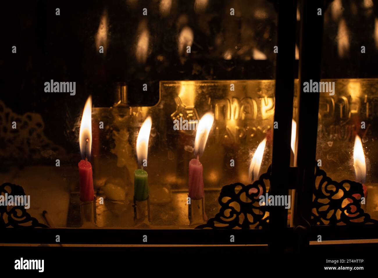 Multi Colored Wax Hanukkah Candles Burn In A Menorah During