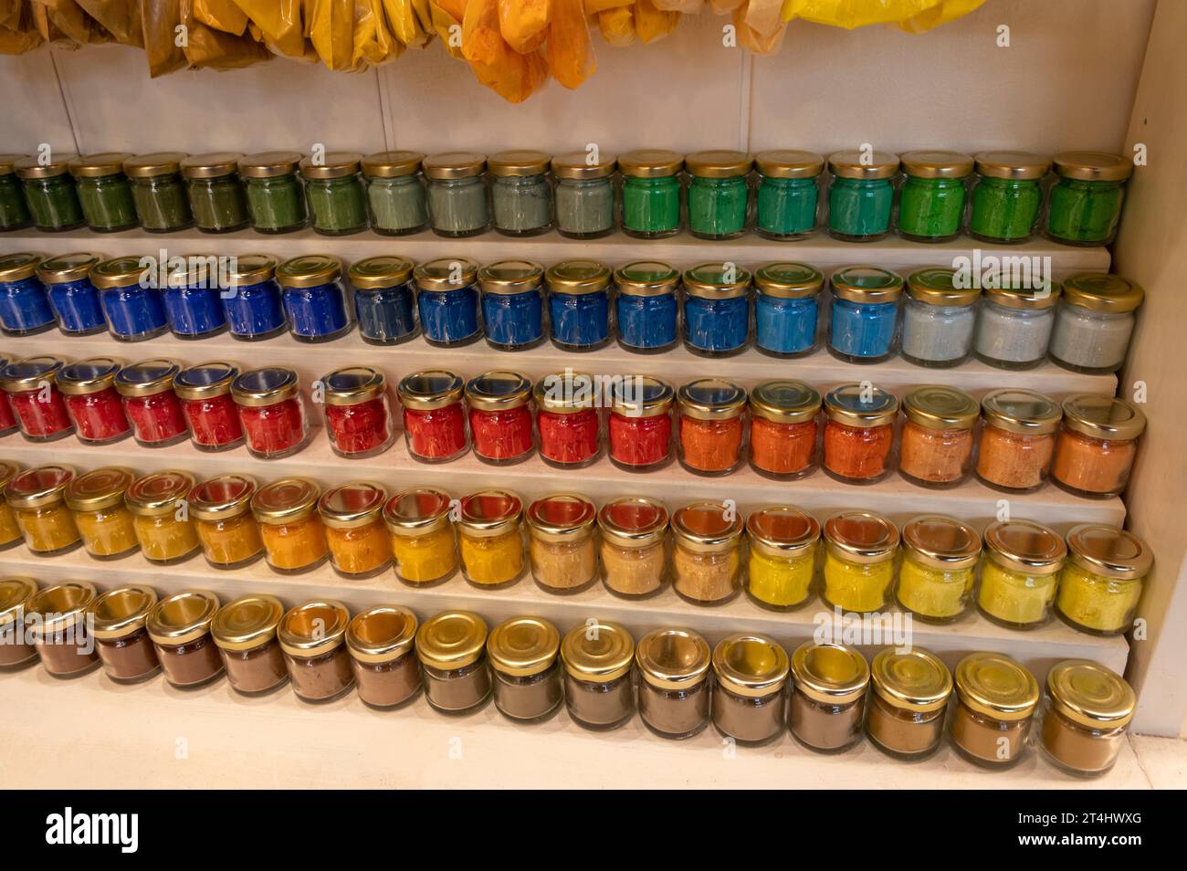 A range of pure colour pigments in small jars on sale in an art shop in ...