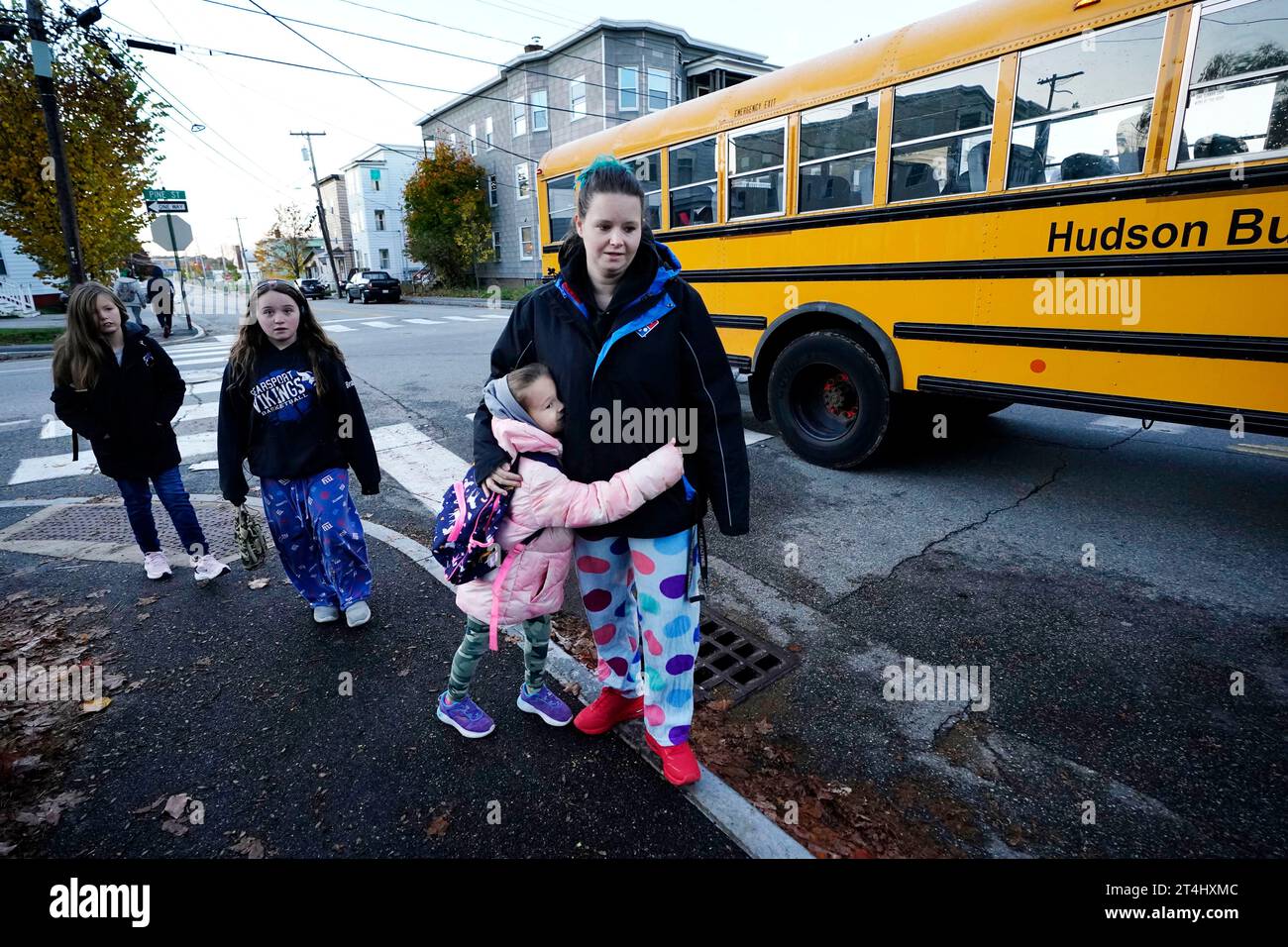 Adrienne Dyment is hugged by her daughter Paizley as the school bus ...