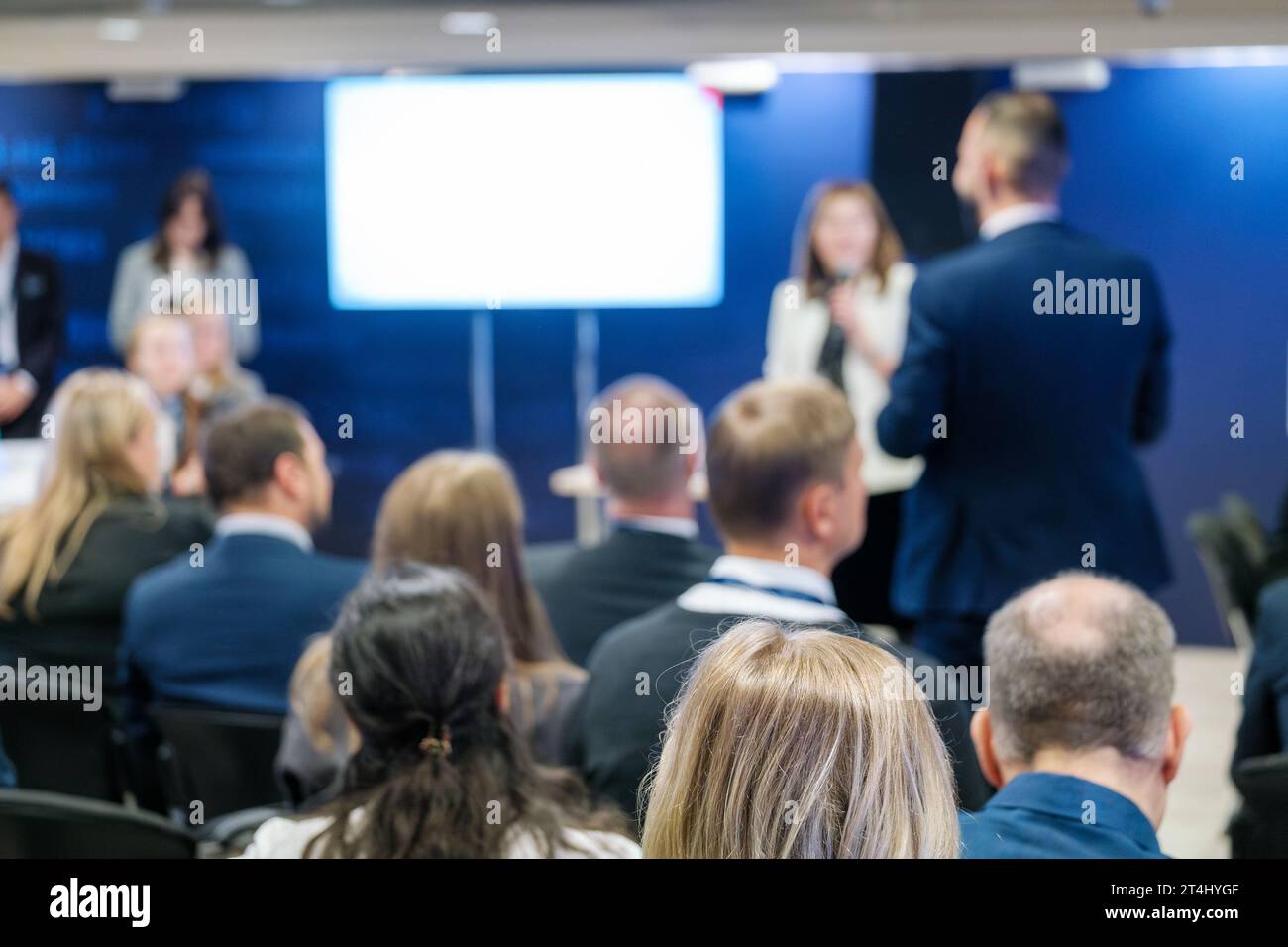 Back view of businessman discussing strategy with female speaker during ...