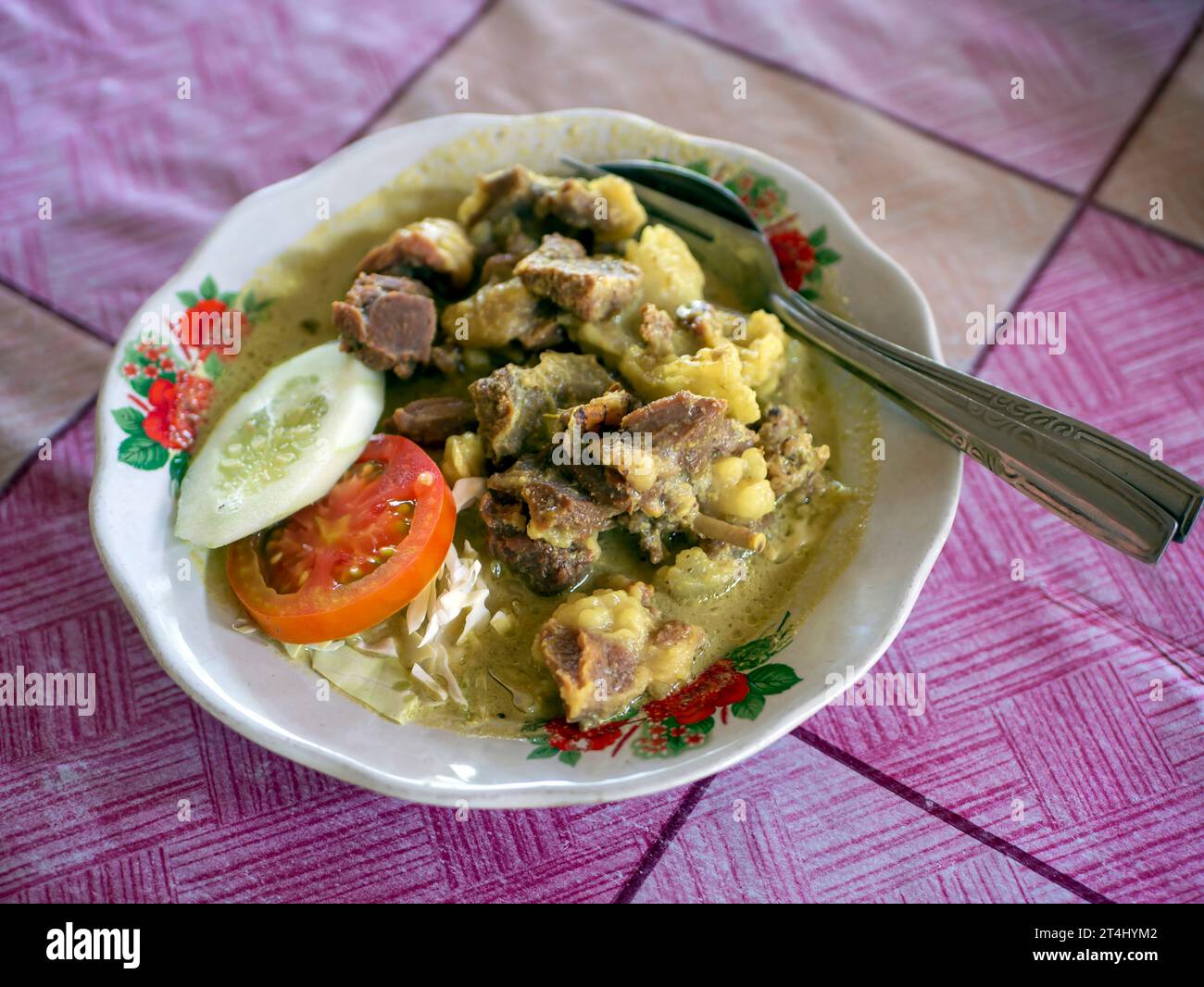 Tongseng Kambing, a spicy curry made from goat meat, in shallow focus ...