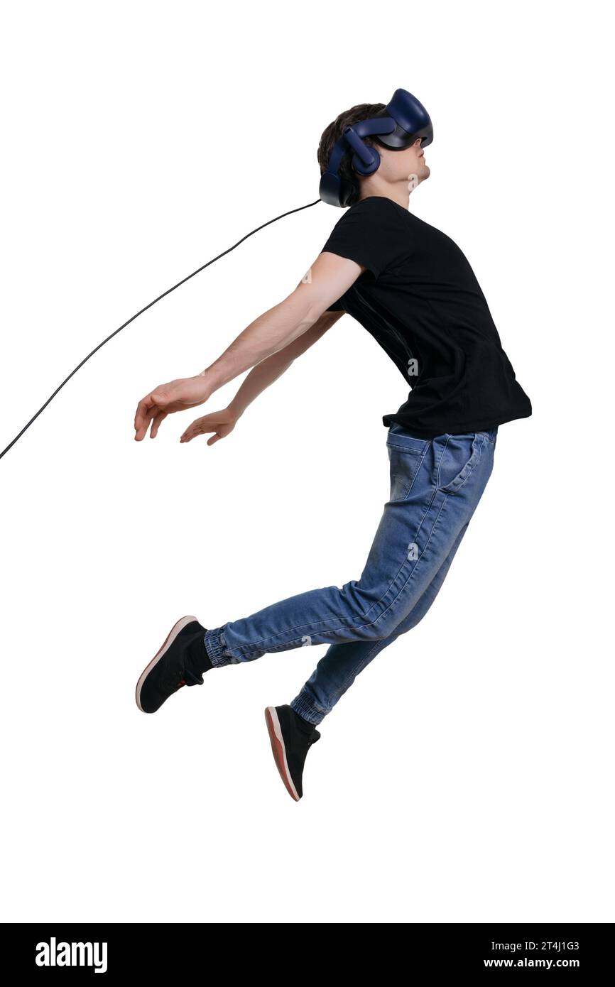 Excited young male in VR glasses flying through spase. Using VR headset ...