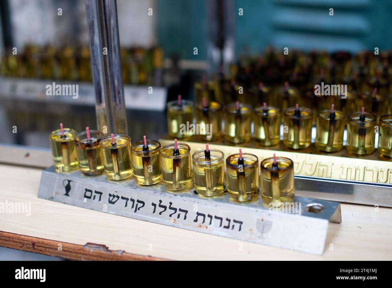A Hanukkah menorah with glass vials filled with oil and new wicks ready ...