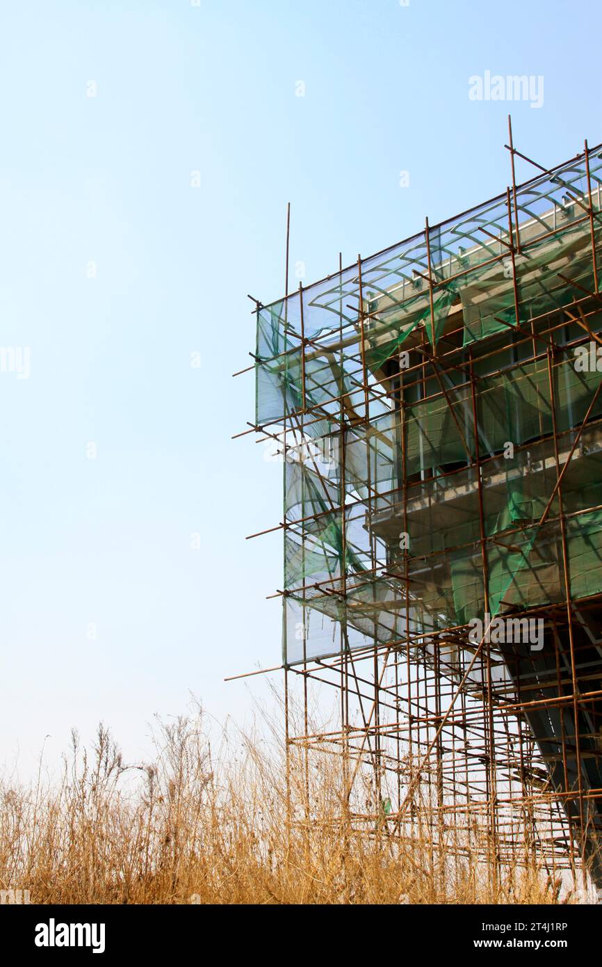 Unfinished buildings outside the scaffolding and protective screening ...