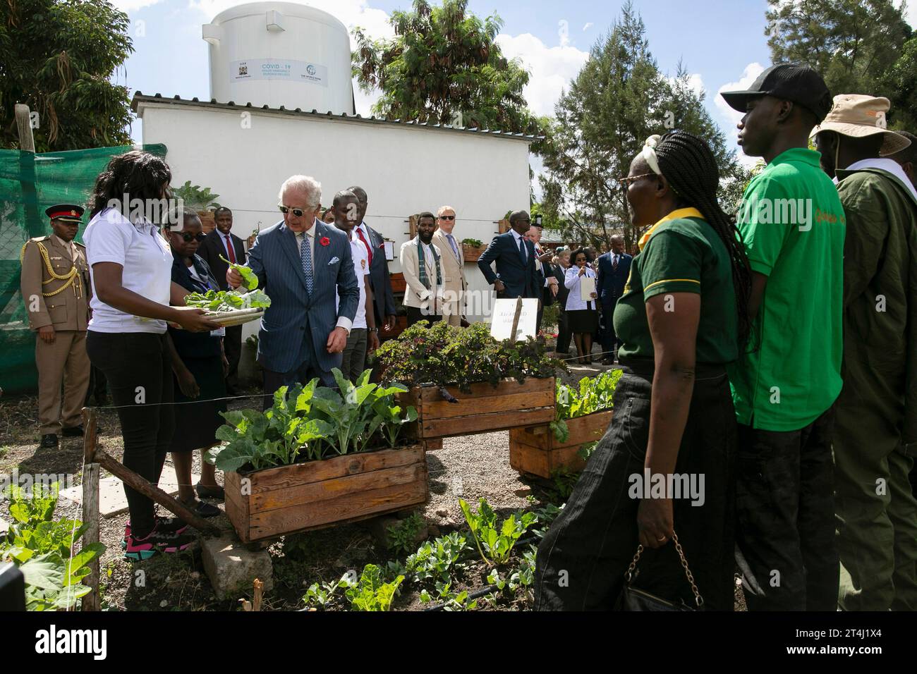 Britain's King Charles III, centre, looks at plants during a visit to ...