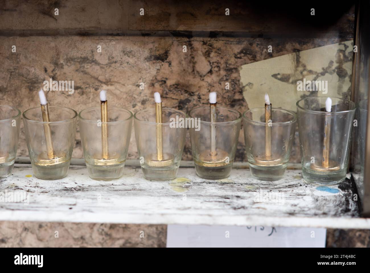 A Hanukkah menorah with glass vials filled with oil and new wicks ready ...