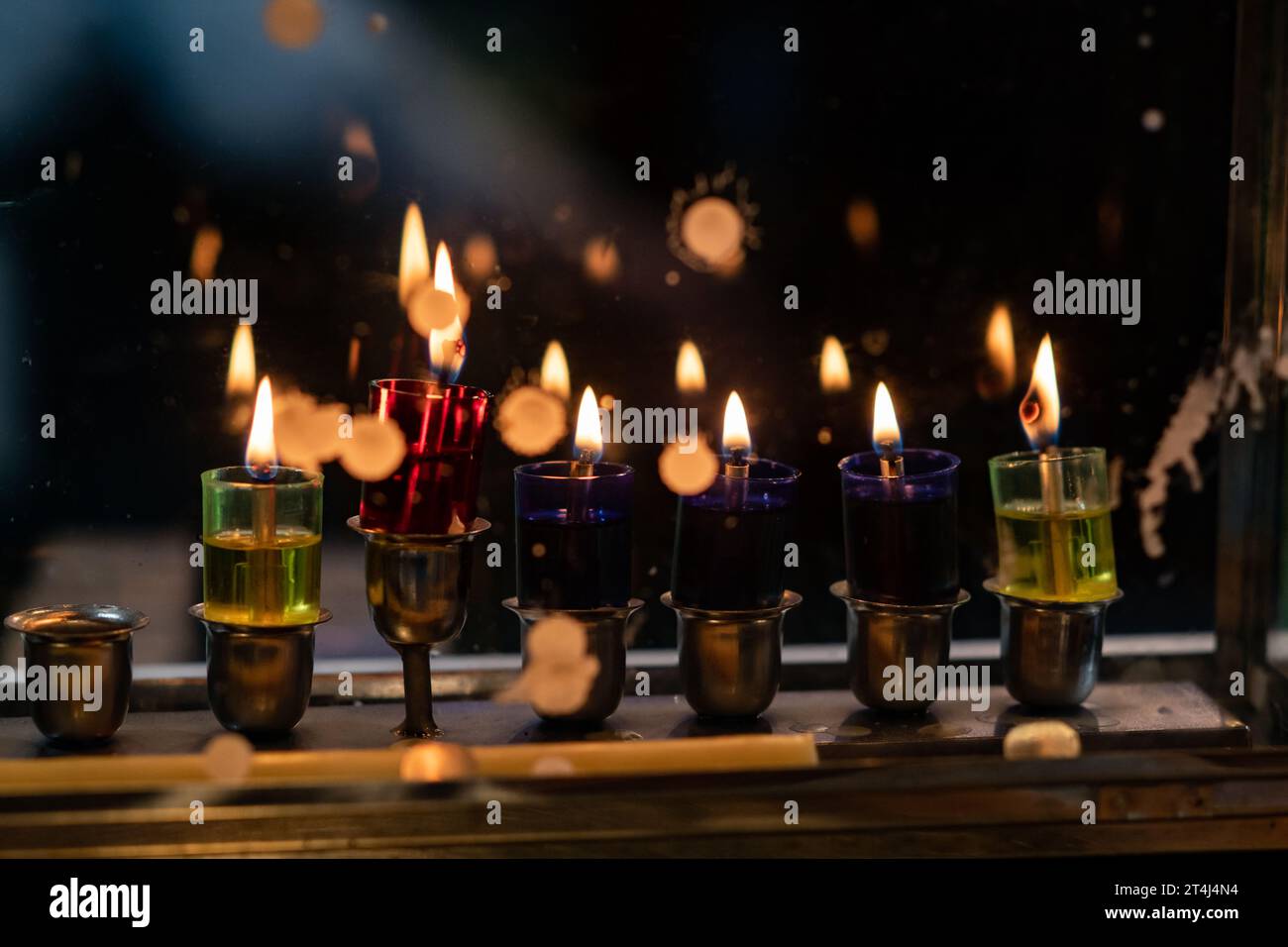 Multi-colored glass vials hold oil and wicks to light the Hanukkah ...
