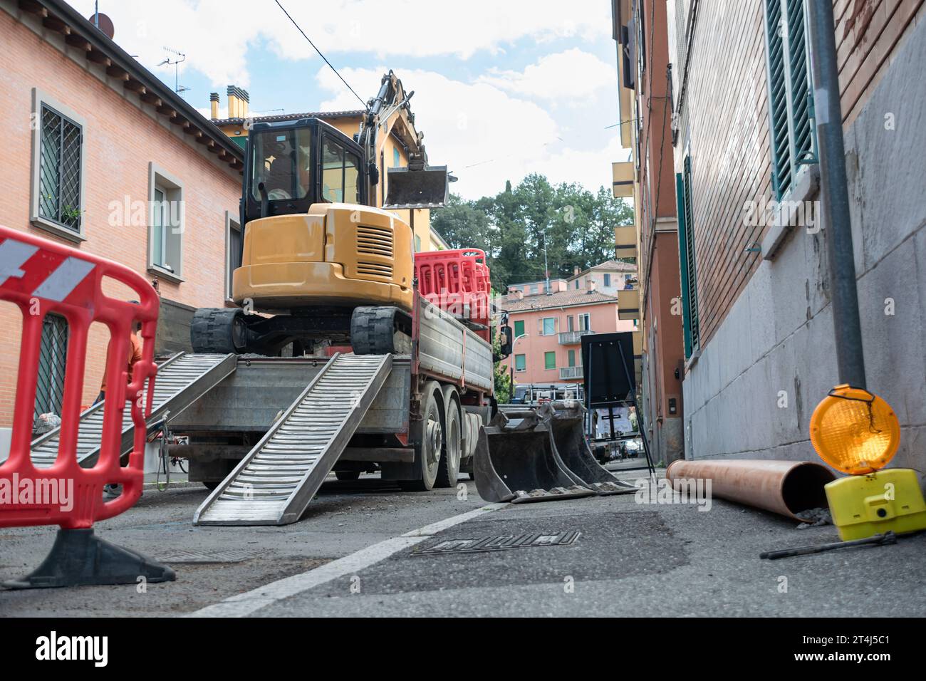 Construction Area with Operators deploying barrier, excavator and ...