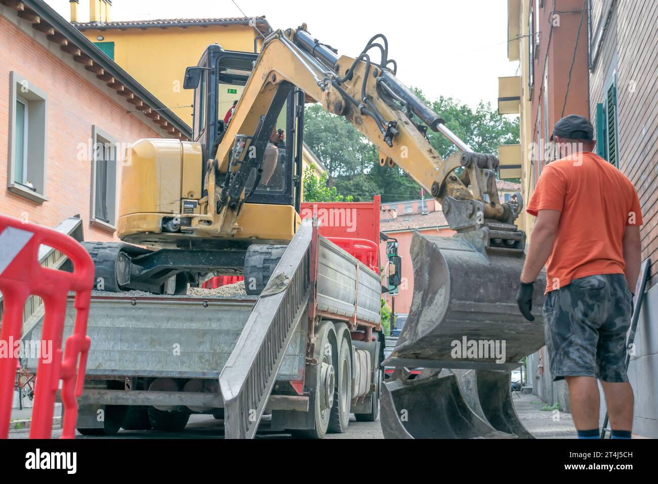 Construction Area with Operators deploying barrier, excavator and ...