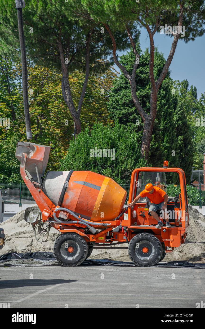 Small Cement truck transporting and turning dry cement by skilled ...