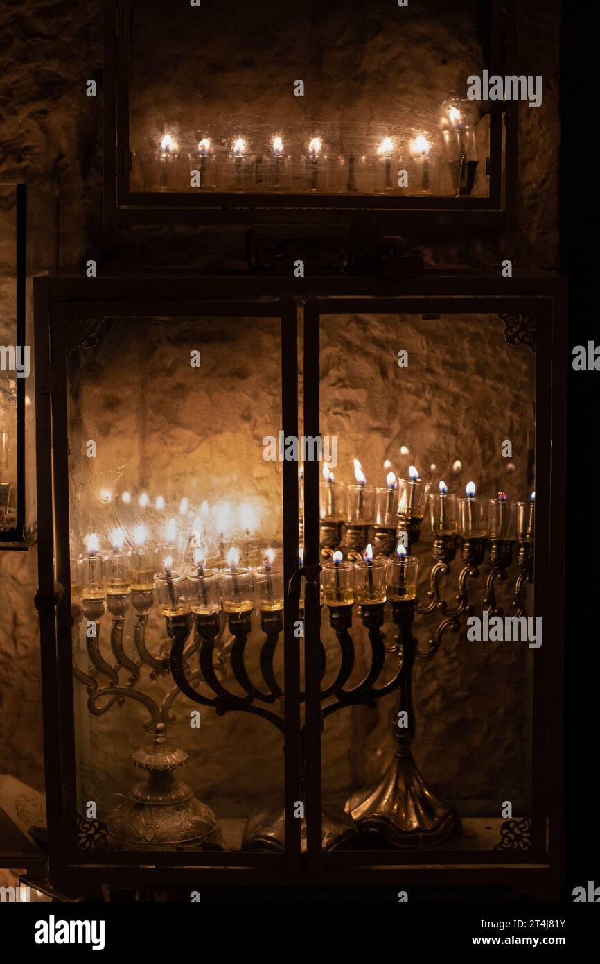 Golden glow of a Hanukkah menorah with oil lights burning in Jerusalem ...