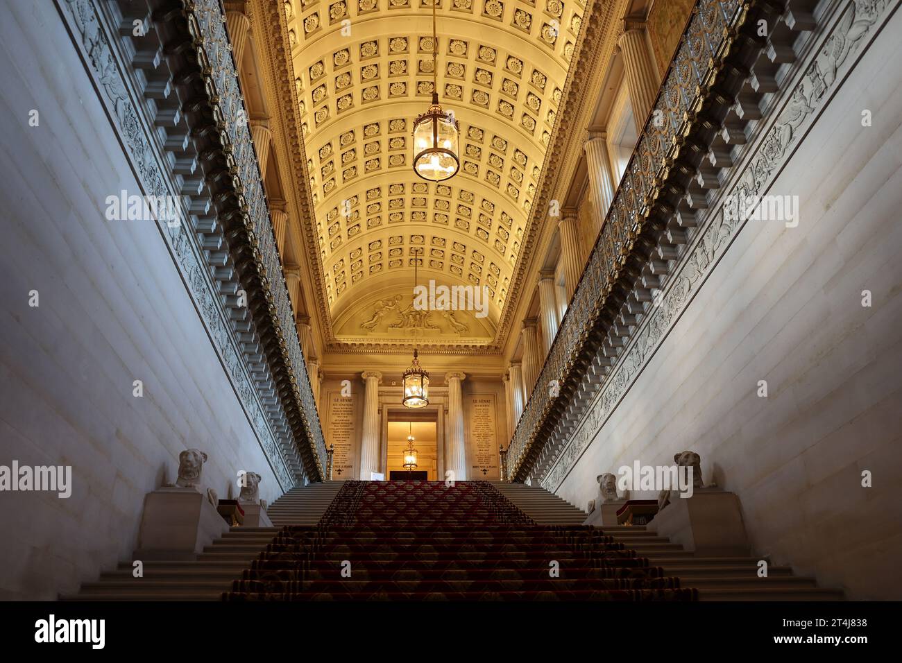 This image features an ornate staircase in a grand building, accented ...