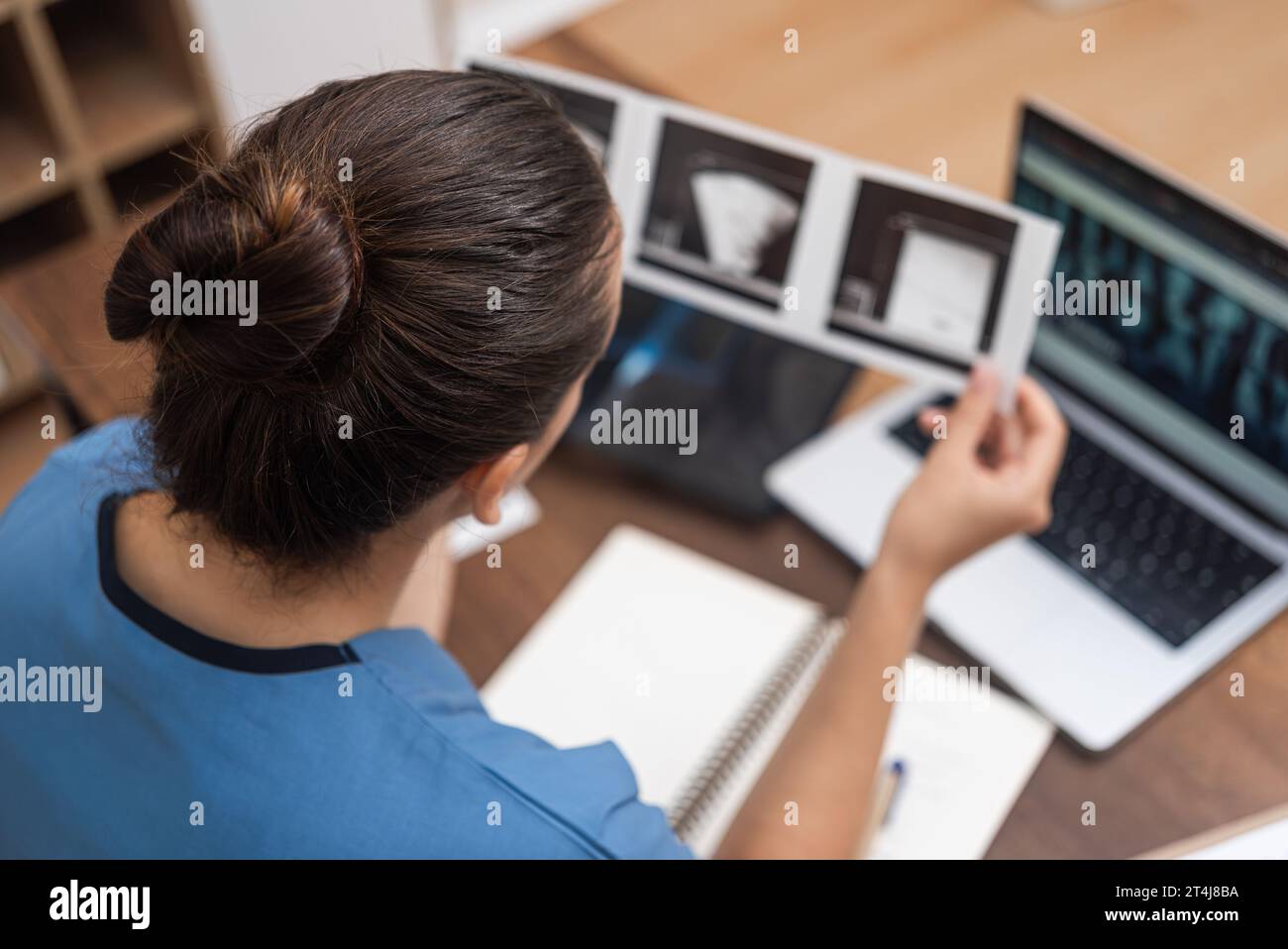 Female doctor examines images of patient ultrasound examination sitting ...