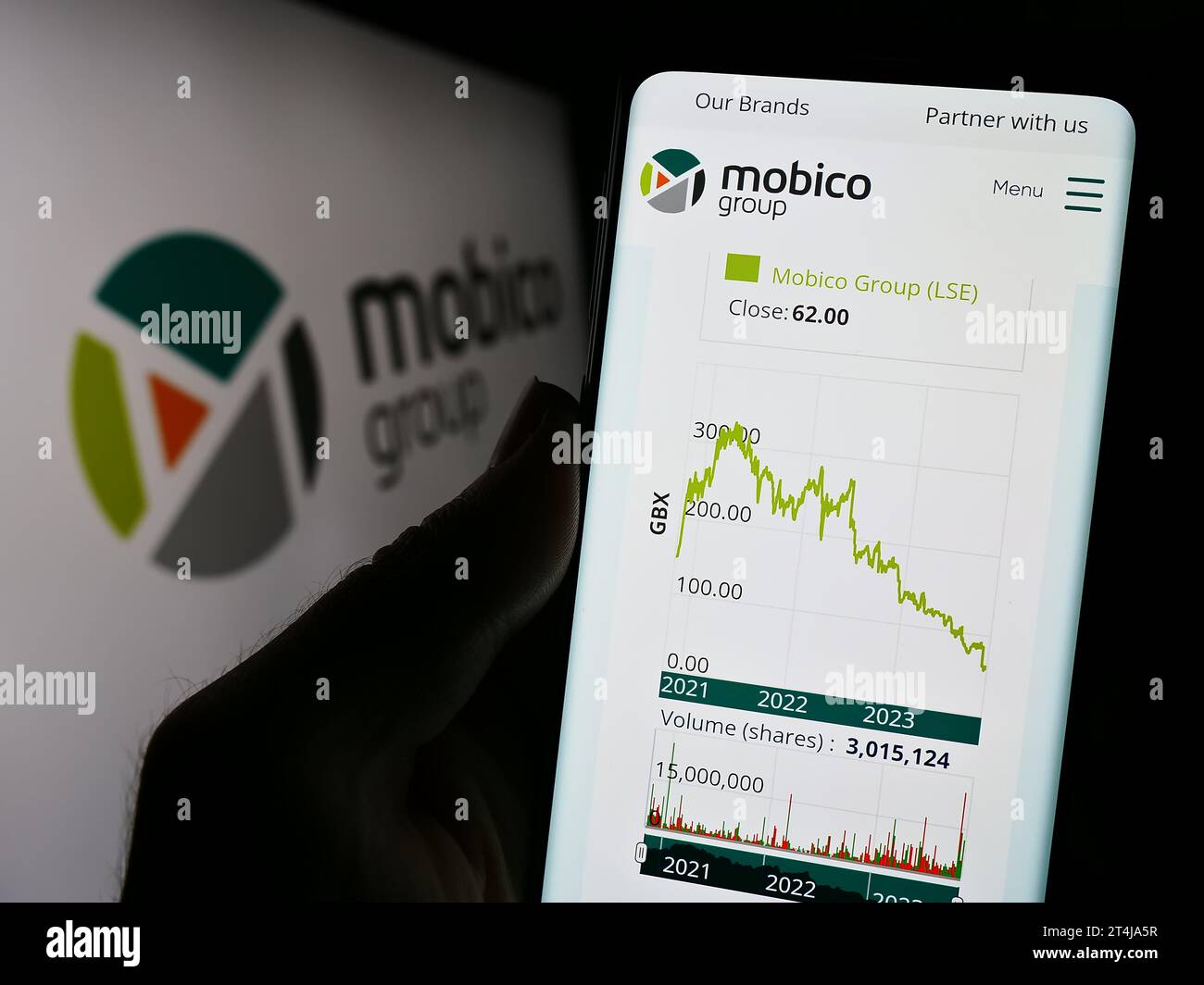 Person holding cellphone with webpage of British public transport ...