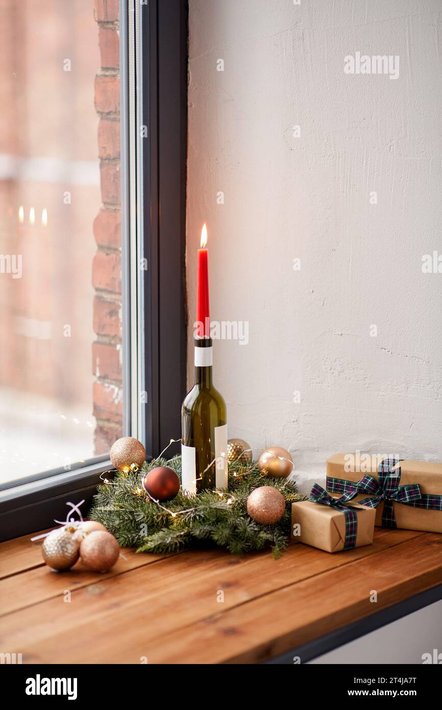 christmas wreath with candle burning on bottle Stock Photo - Alamy