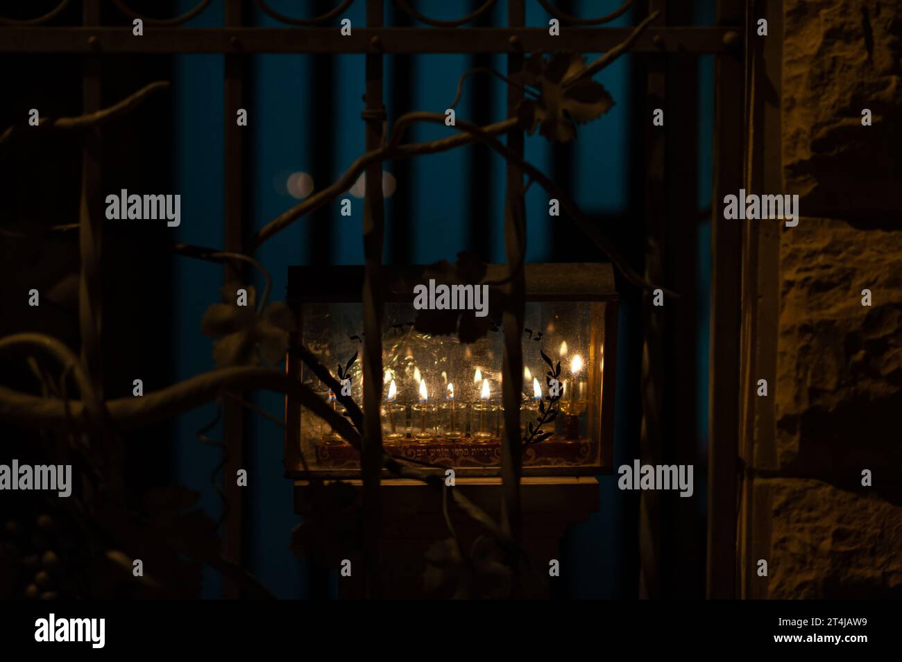 Golden glow of a Hanukkah menorah with oil lights burning in Jerusalem ...