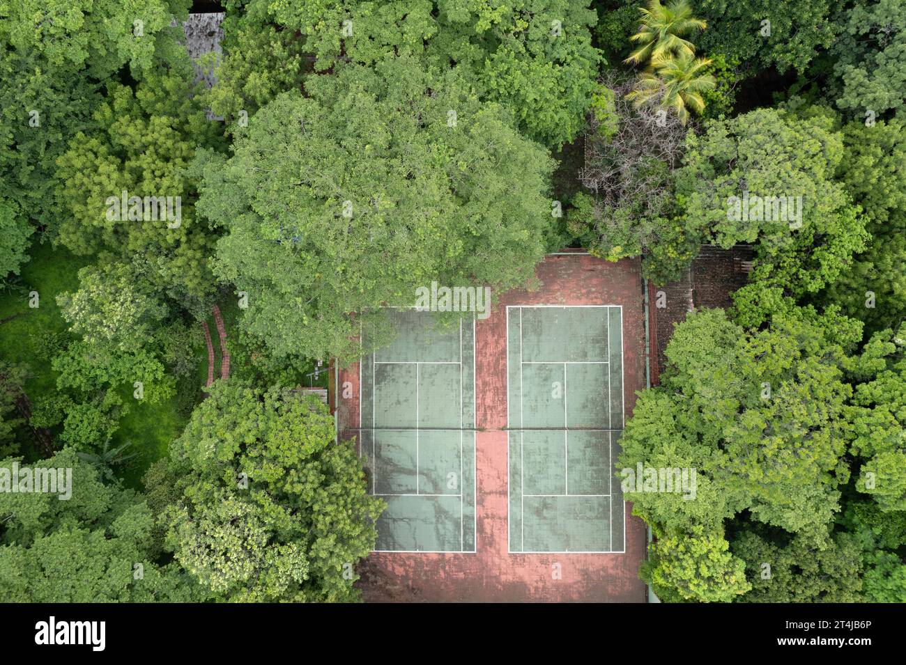 Aerial photograph captures red clay tennis court nestled in the midst ...