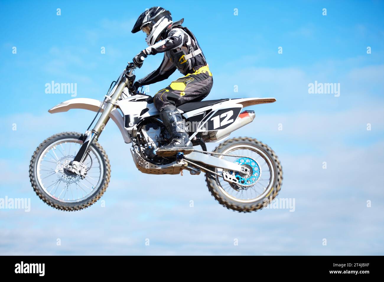 Person, motorcycle and air jump in blue sky as professional in action ...