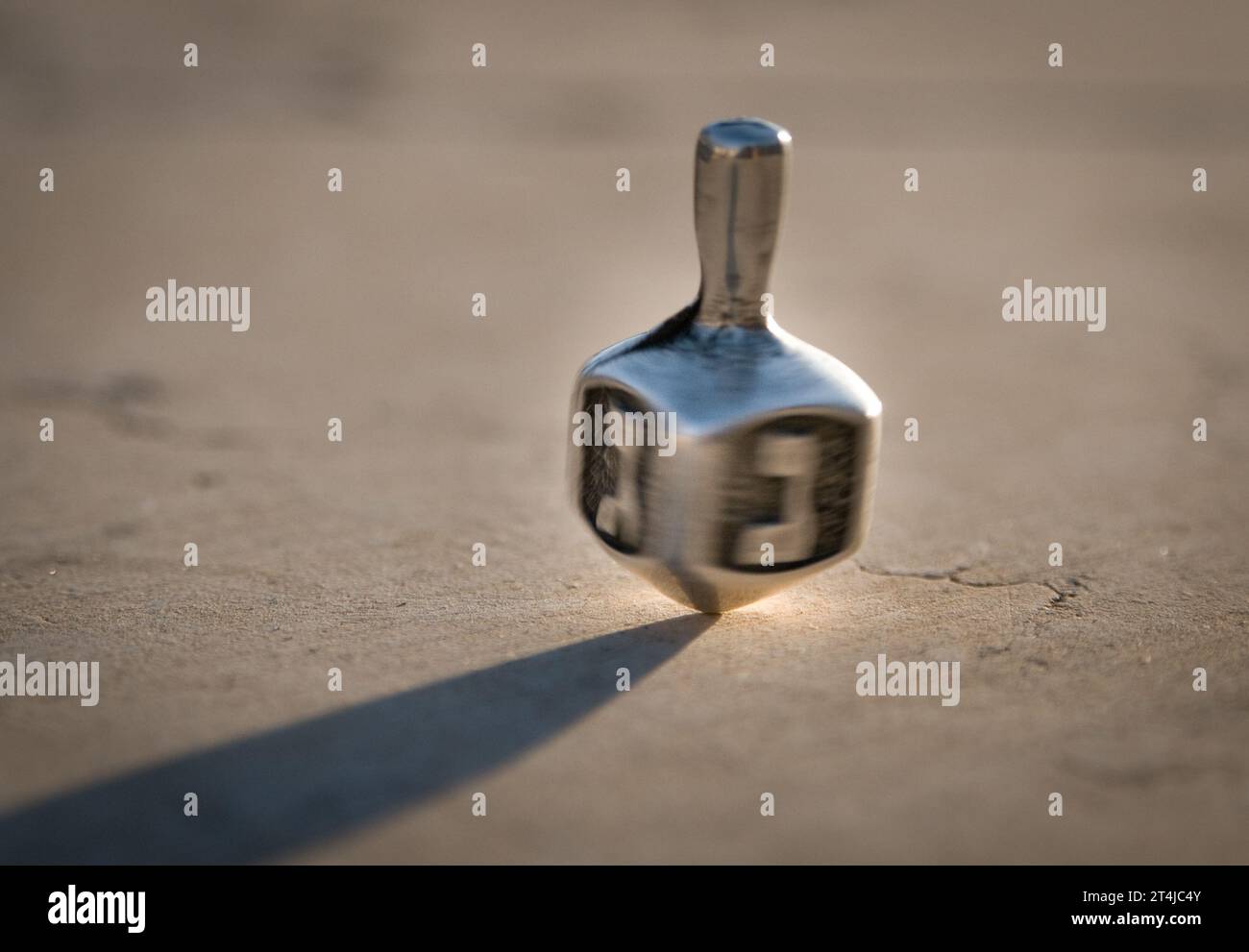 Small, silver cast silver Hanukkah dreidel, a top used to play a game ...