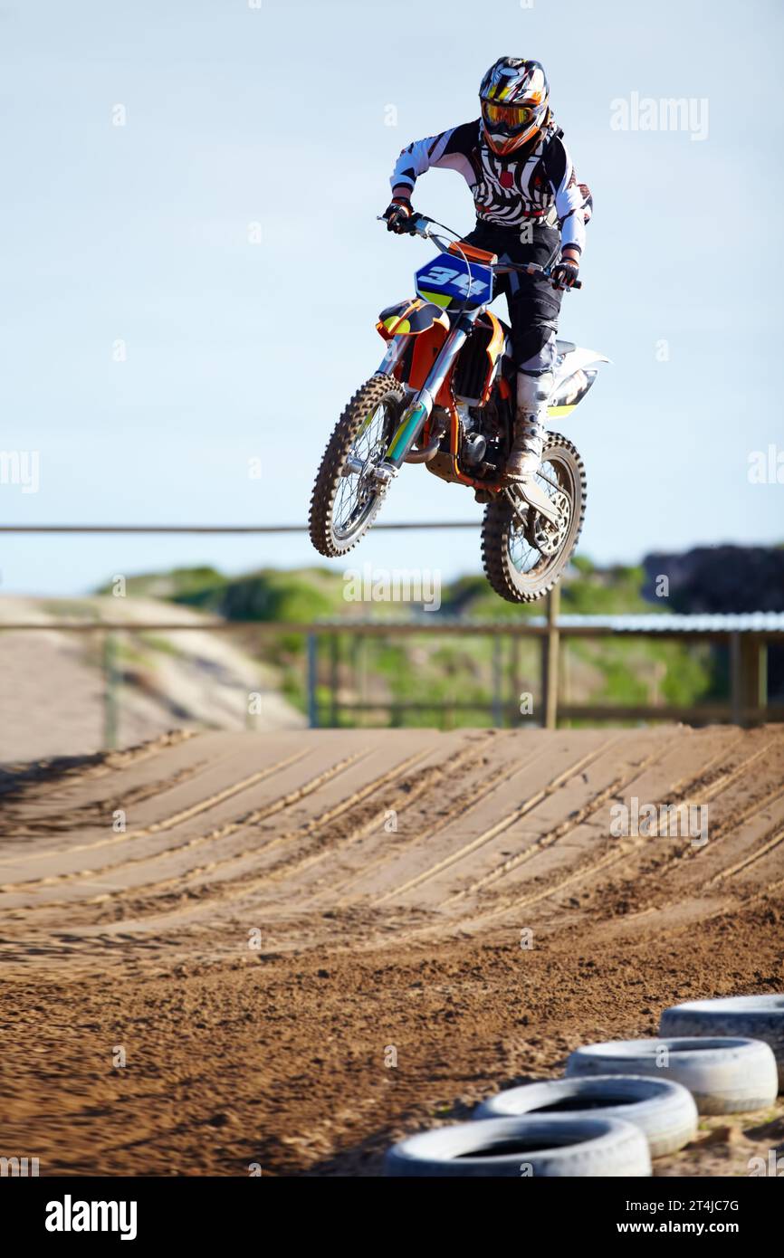 Person, motorcycle or bike jump on race track as professional in action ...