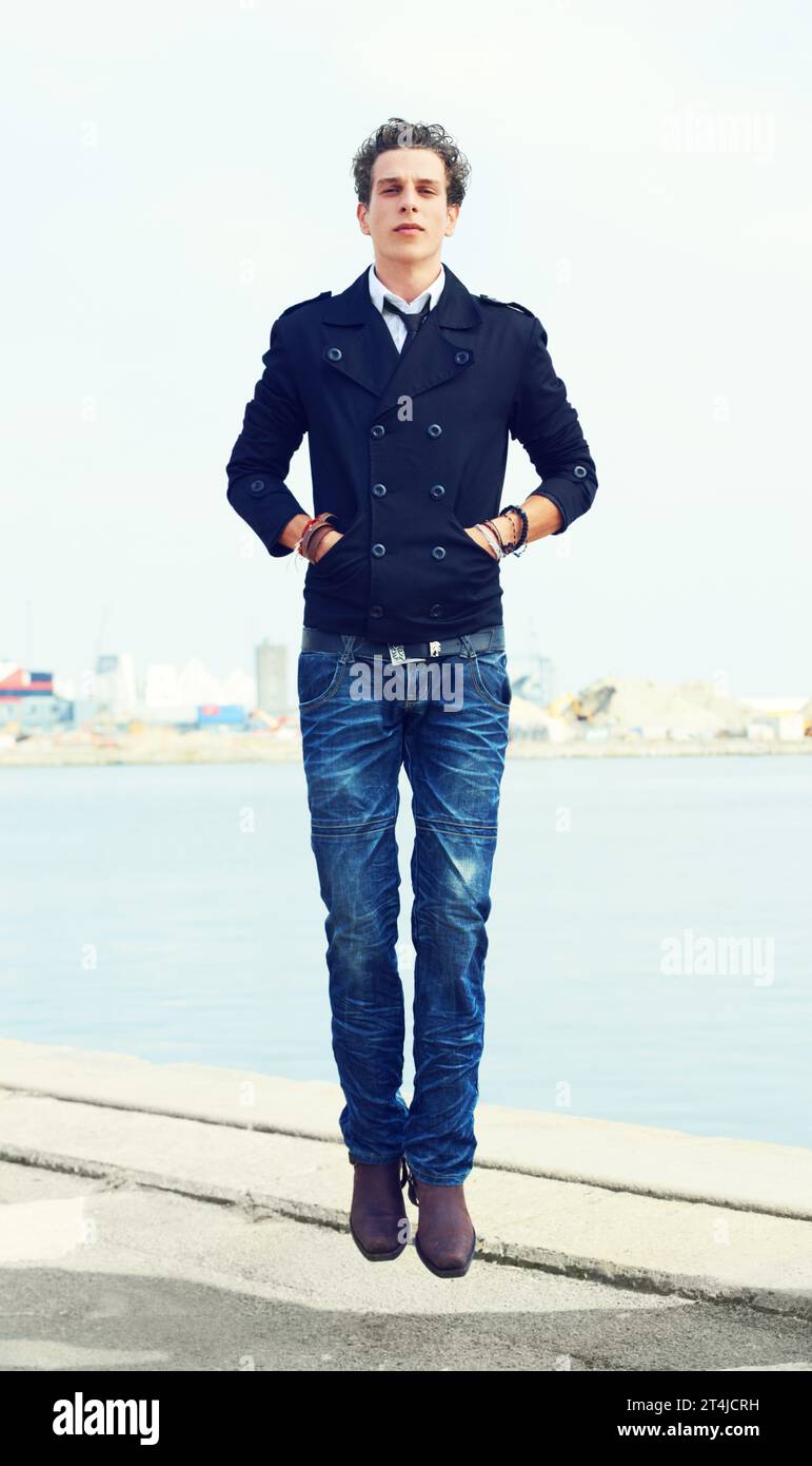 Portrait, punk and man with jump, water and fashion with edgy style ...