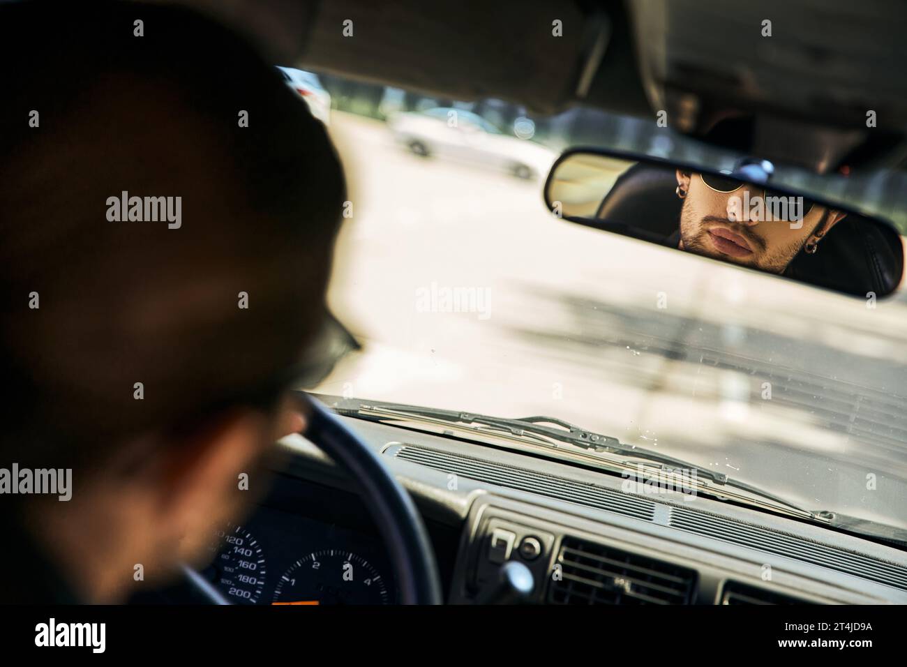 handsome sexy male model with sunglasses behind steering wheel and ...