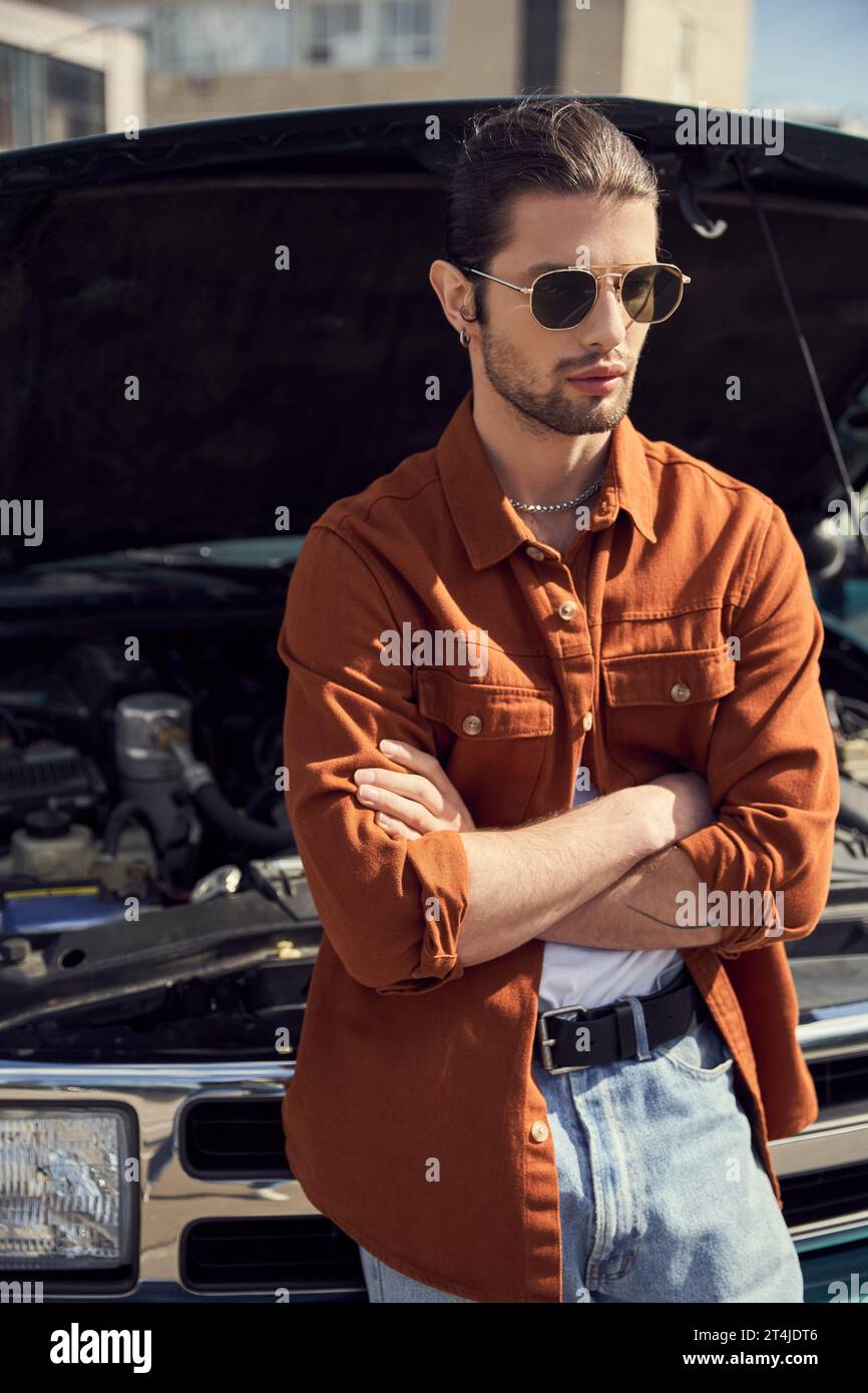 handsome eye catching male model in stylish attire posing next to his ...