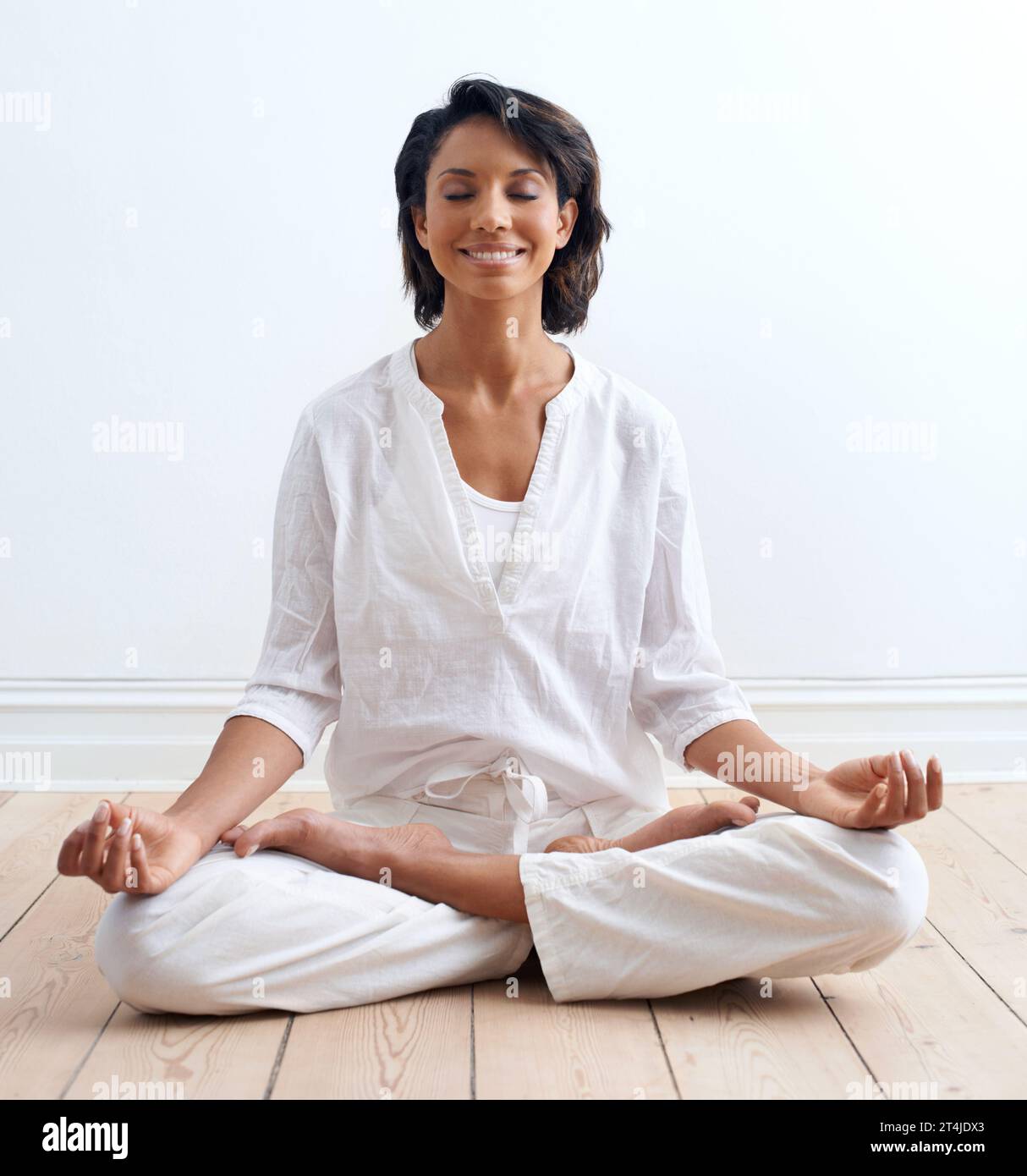 Woman, smile and meditate in lotus position at home, relax and peace or ...