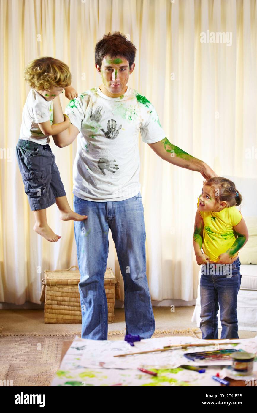 Family, paint and messy children on dad, childhood and crazy in living ...