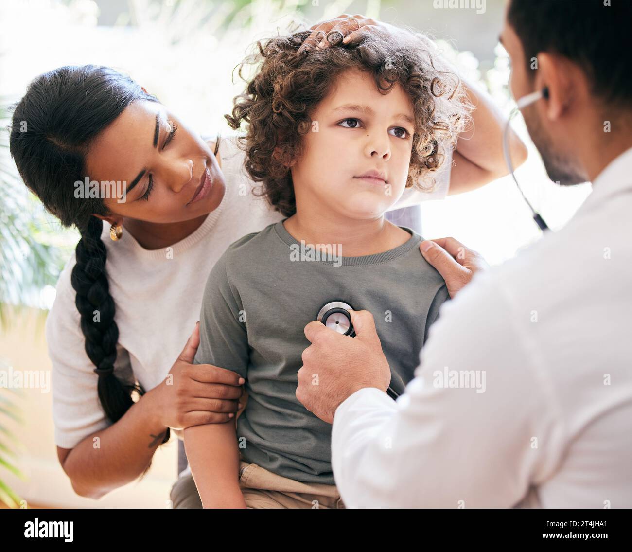 Please make him better. a little boy being examined by an ...