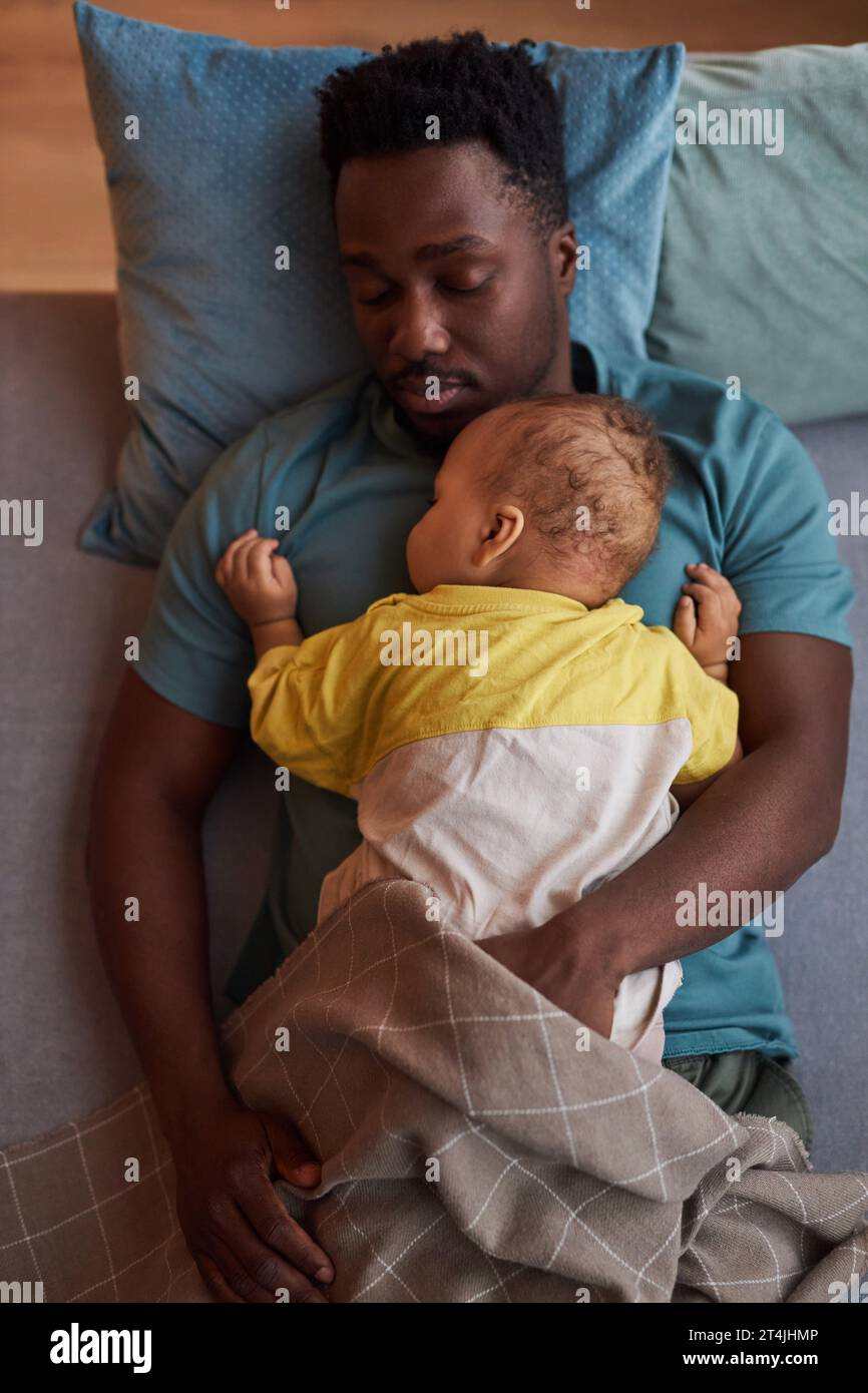 Vertical top view portrait of young African American father with baby ...
