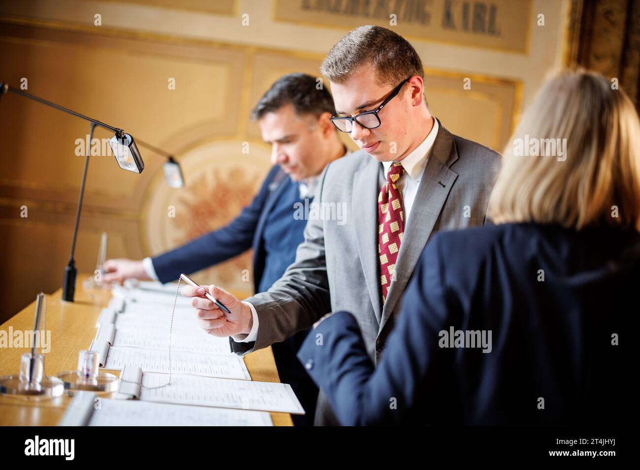31 October 2023, Bavaria, Munich: Daniel Halemba (AfD) signs a list ...