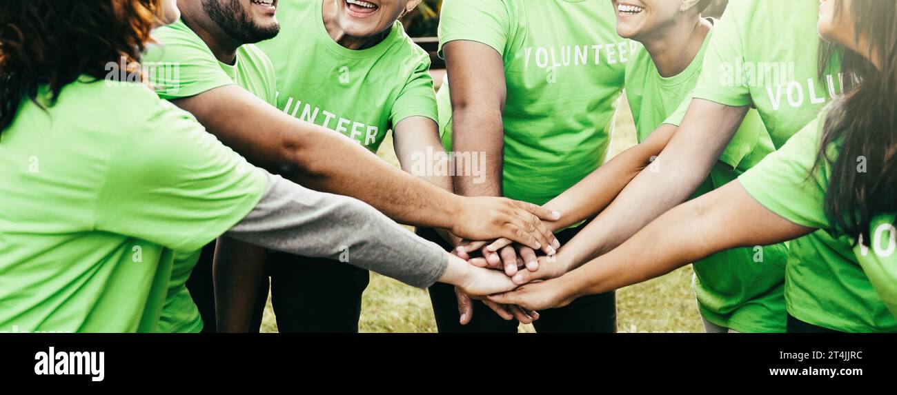 Group of volunteer people stacking hands celebrating together - Charity ...
