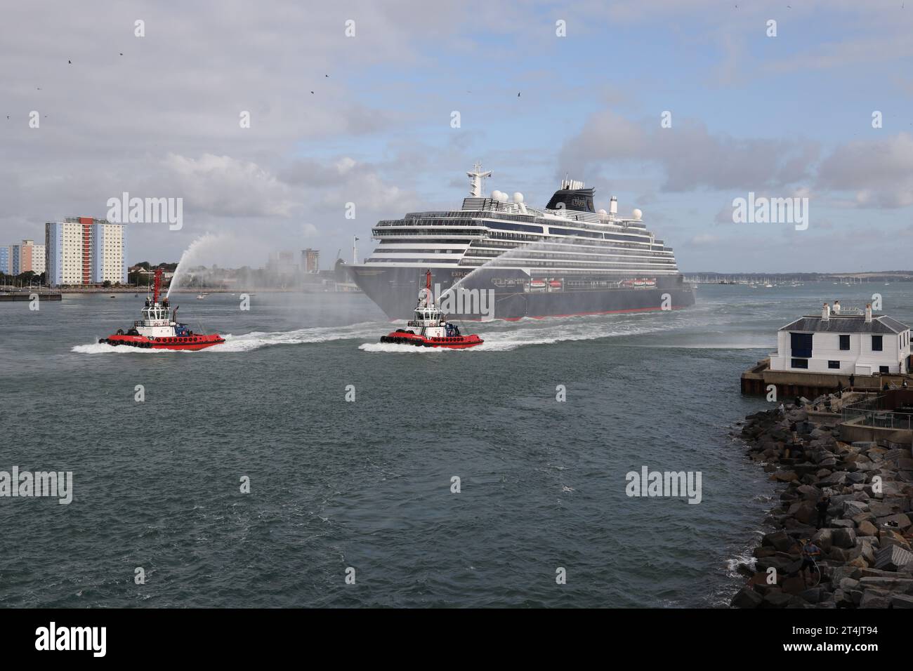 Tugs provide a water jet escort as the MSC Cruises passenger ship ...