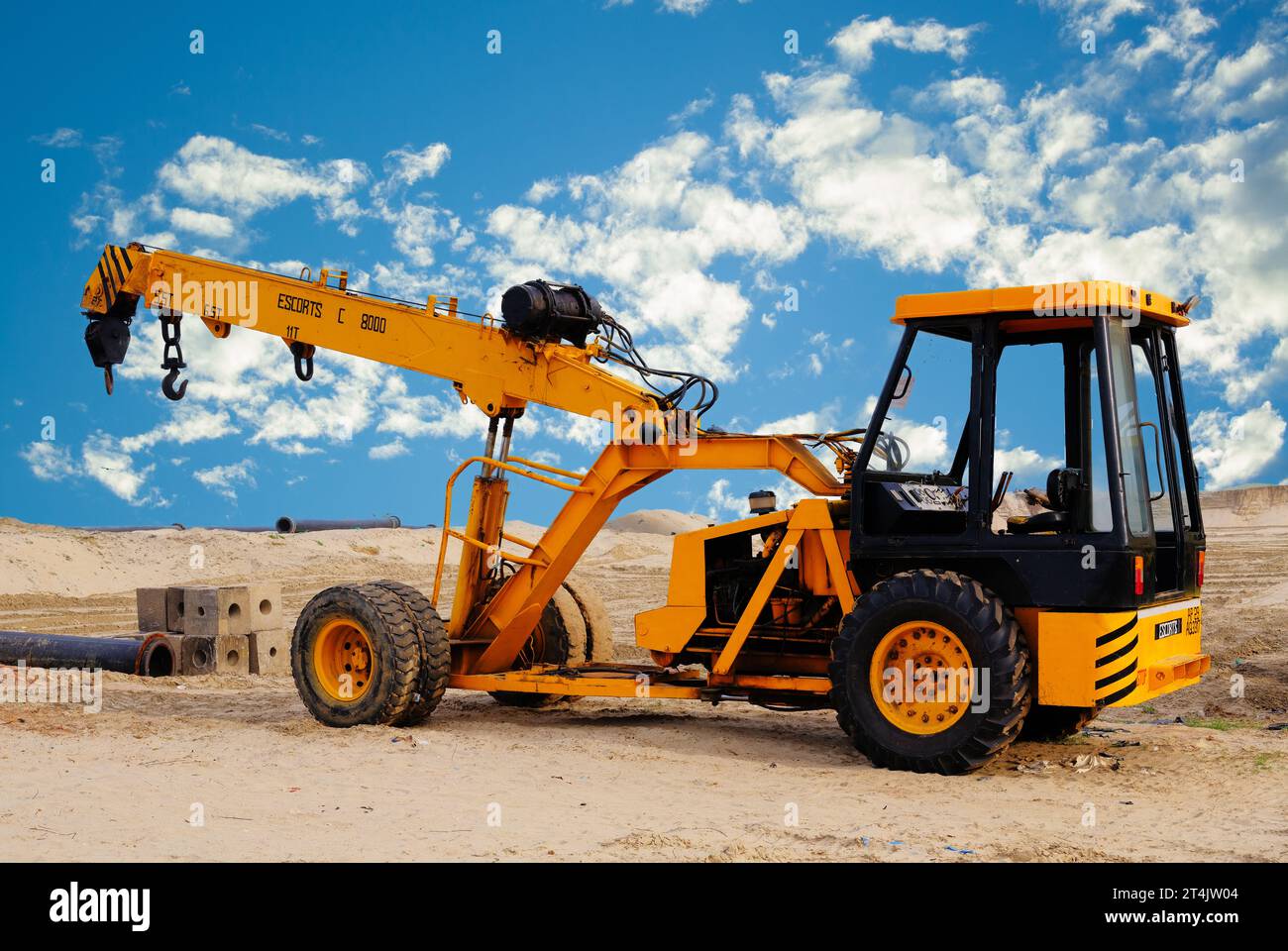 Hydraulic crane parked on a beach to move construction material Stock ...