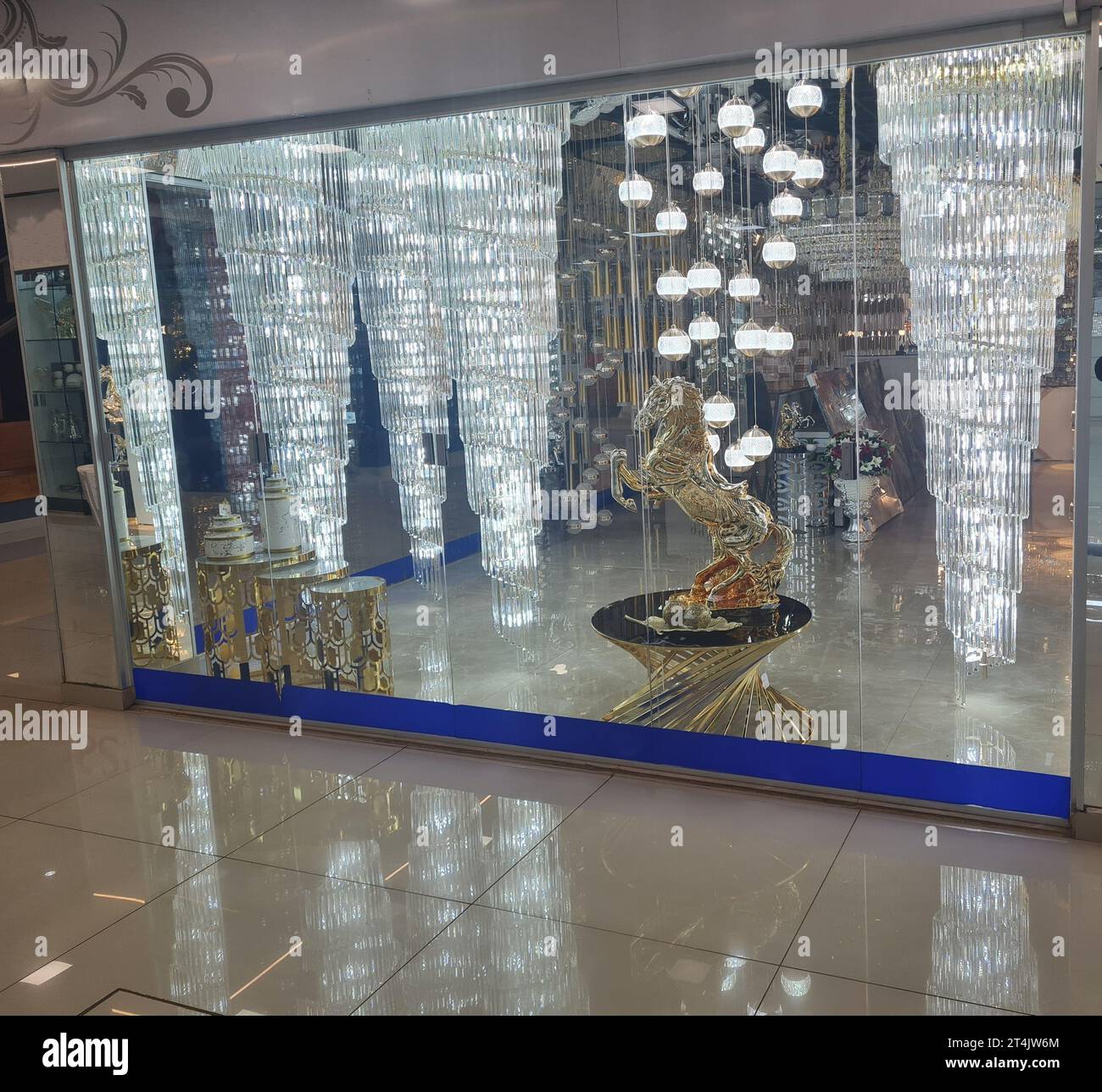 Store window in a shopping mall with a display of various glass items ...