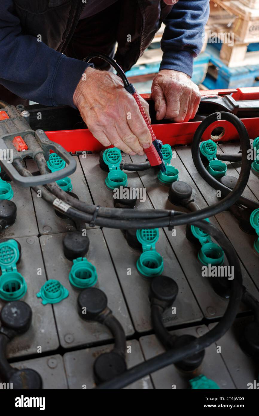 Forklift truck electric batteries being topped up at the regular ...