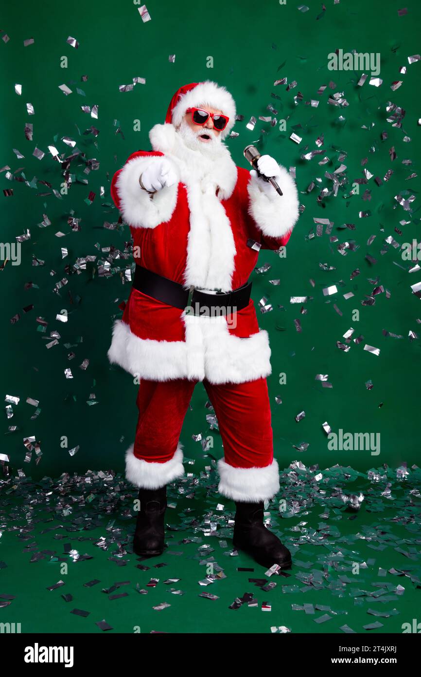 Full length photo of funky cheerful santa dressed red costume pointing ...