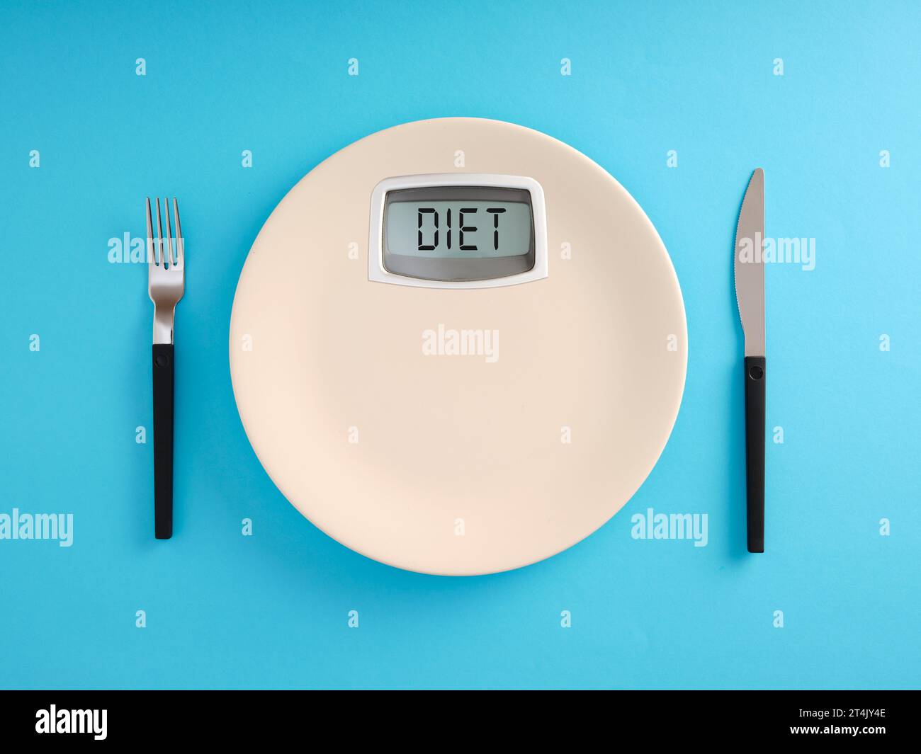 Digital bathroom scale screen with the word diet on a plate with fork ...