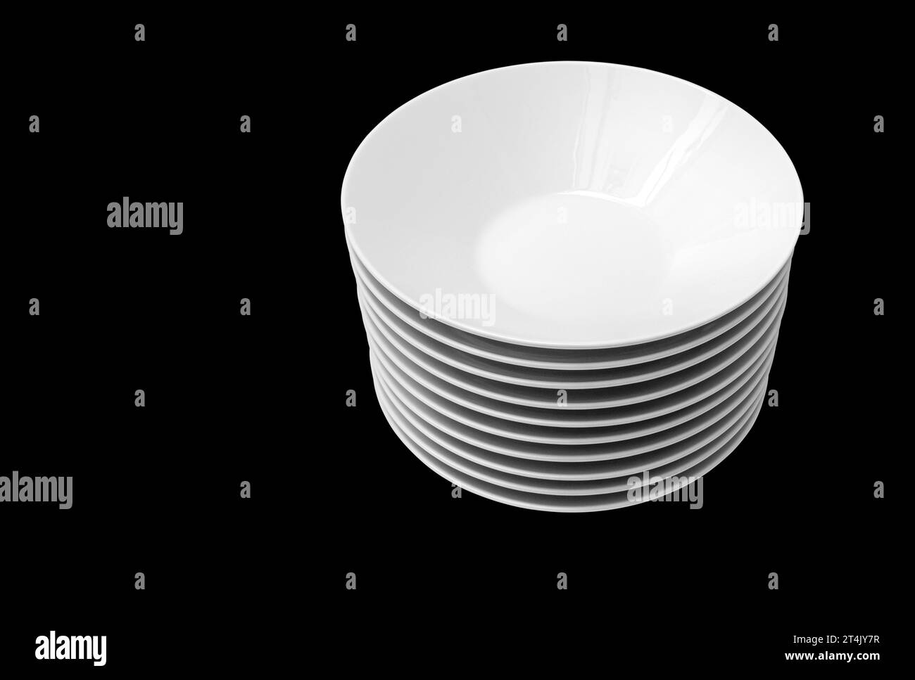 A stack of square white plates isolated on black background with copy ...