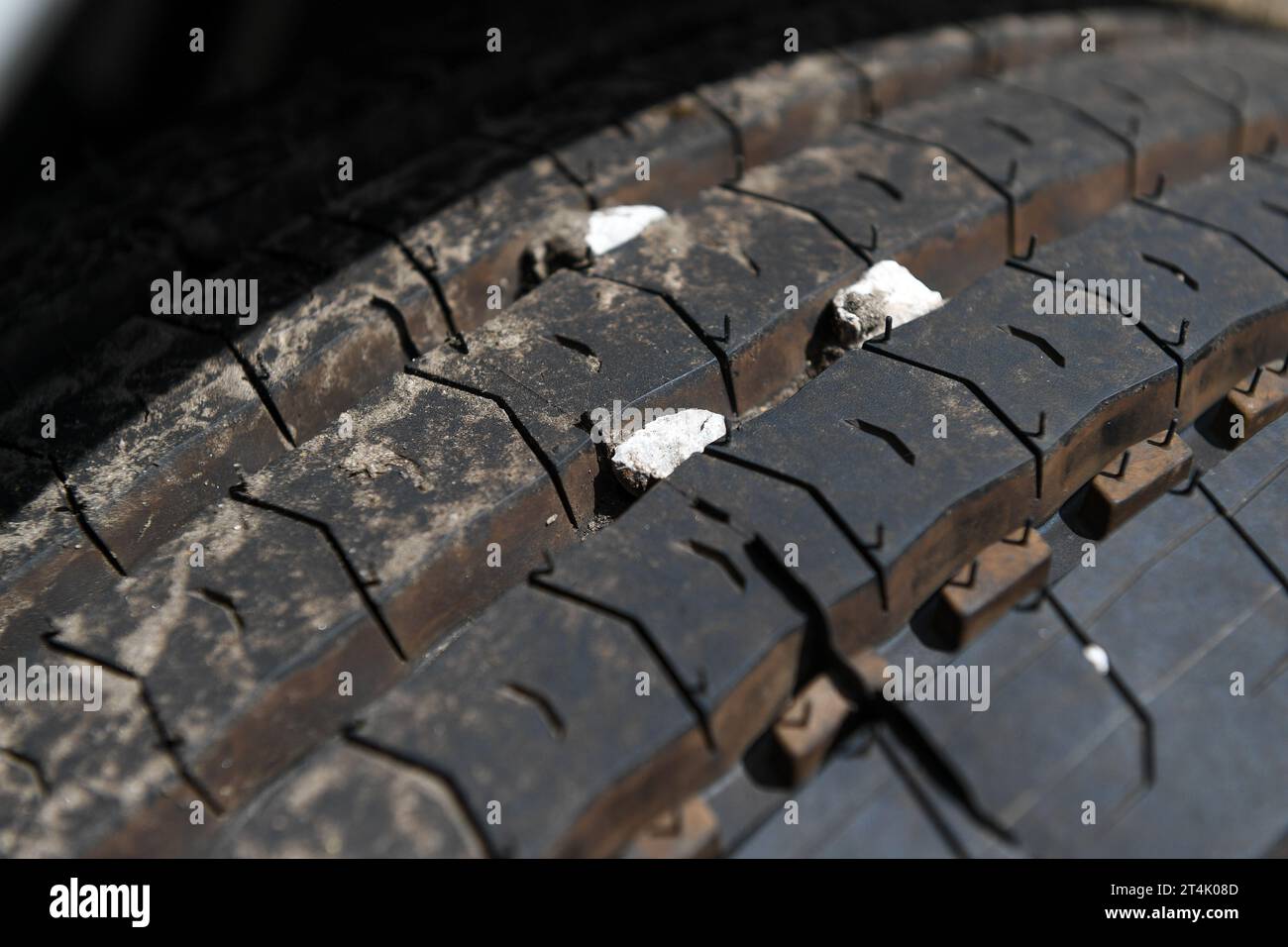 Small stones caught in the tread of truck tyre which can cause a danger ...