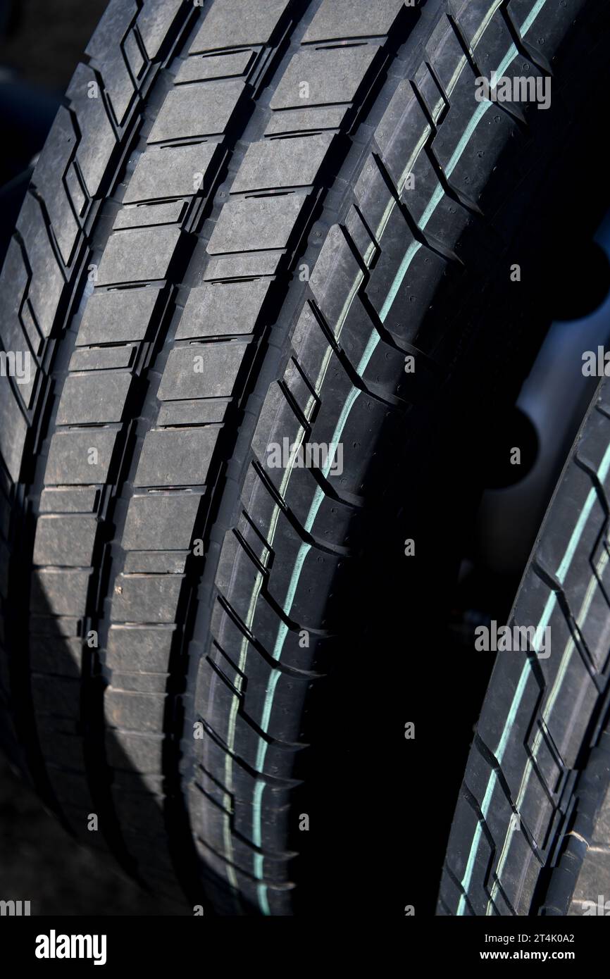 Close up of new truck tyres showing deep tread pattern and safety ...