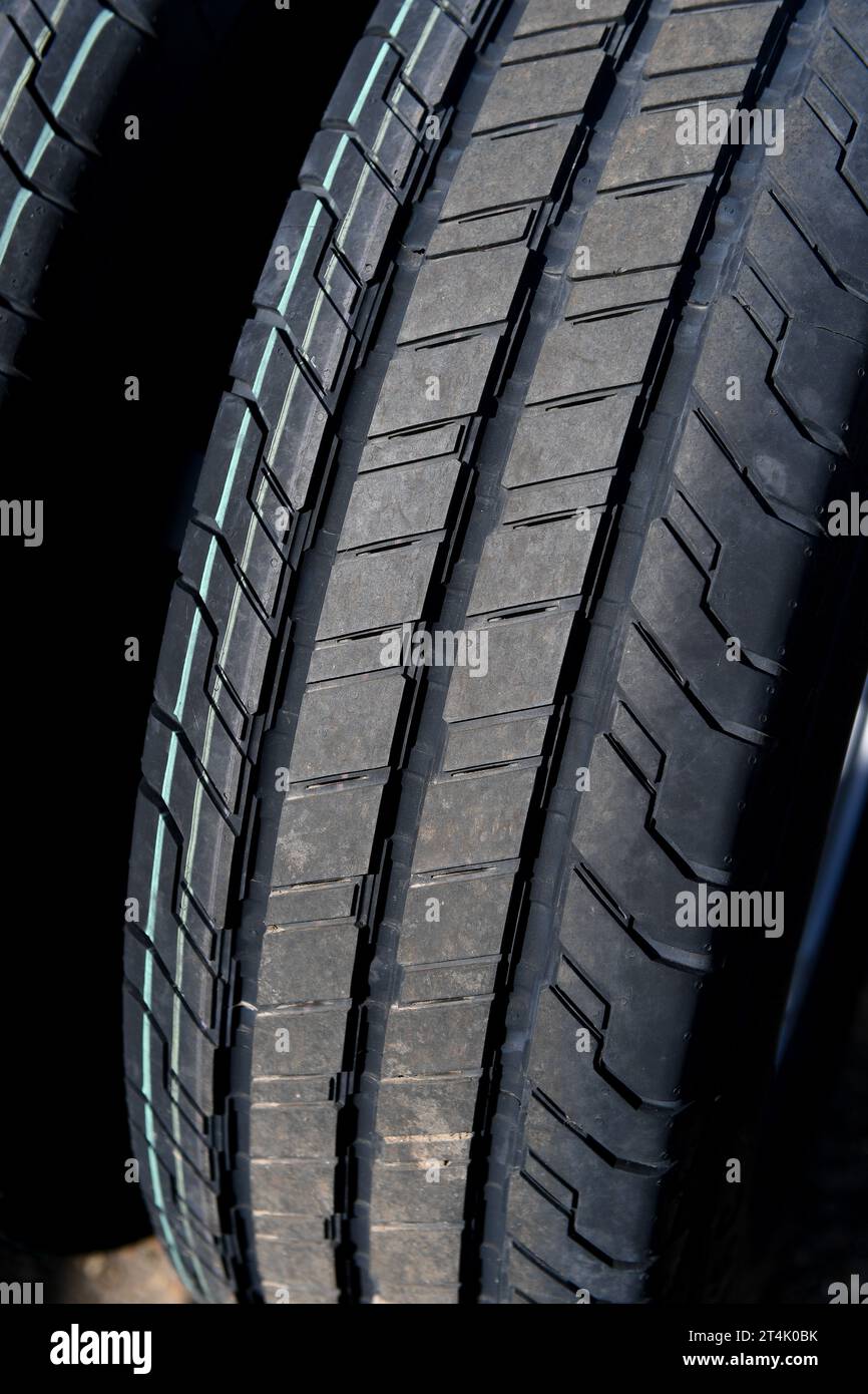 Close up of new truck tyres showing deep tread pattern and safety ...